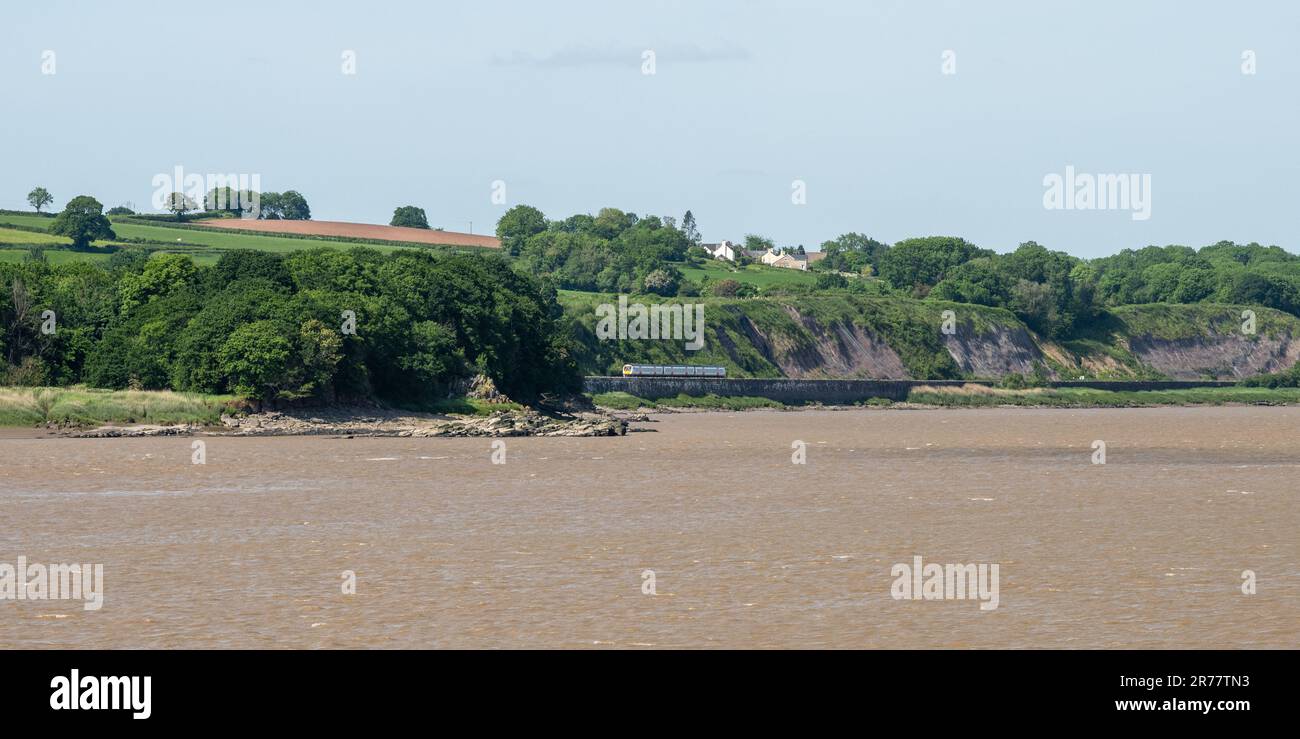 A Transport for Wales passenger train travels alongside the Severn ...