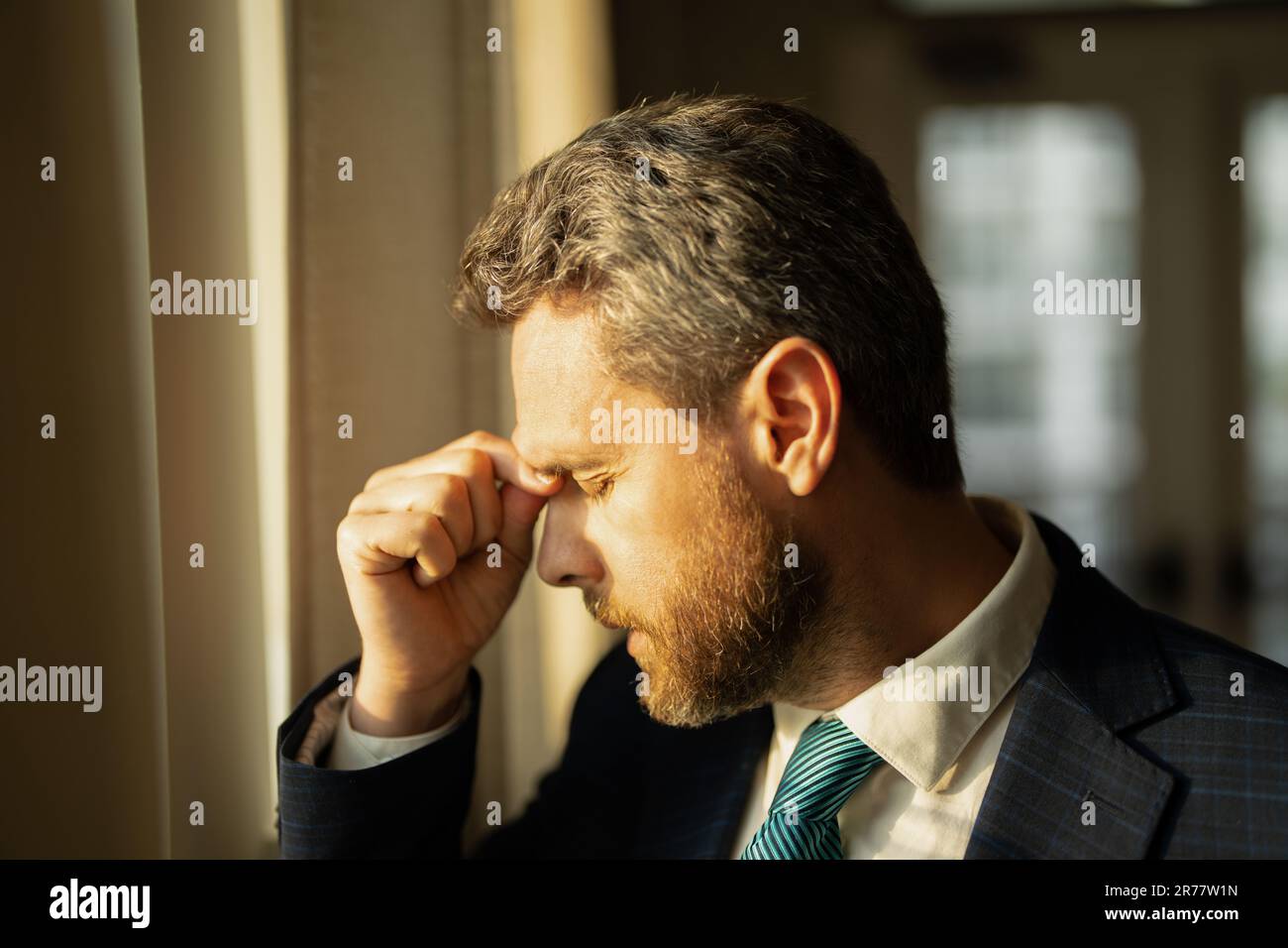 Stressed business man having headache at office. Tired businessman is ...