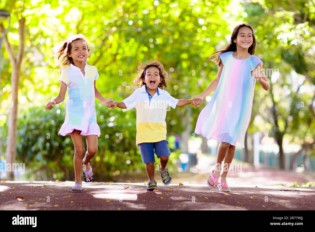 Happy kids play in summer park. Children run and laugh. Summer vacation ...