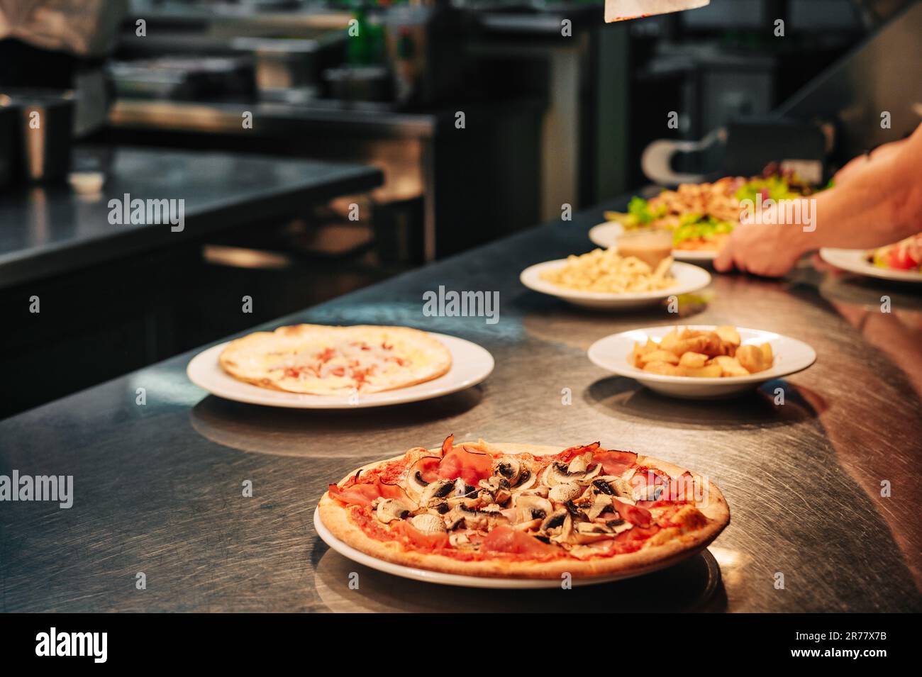 Food orders on the kitchen table in the restaurant Stock Photo - Alamy