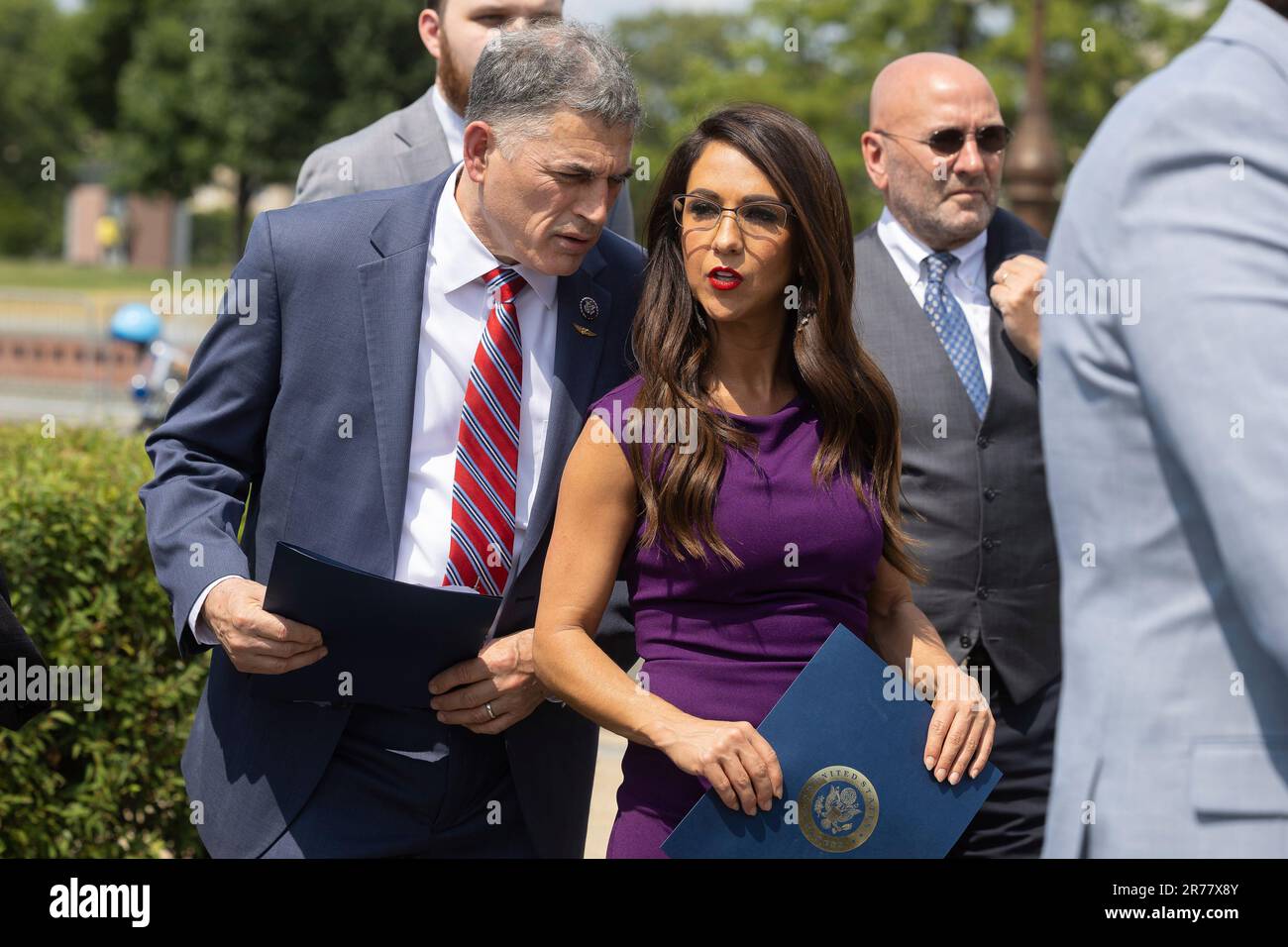 Rep. Andrew Clyde (R-Ga.) speaks with Rep. Lauren Boebert (R-Colo.) during a press conference on ...