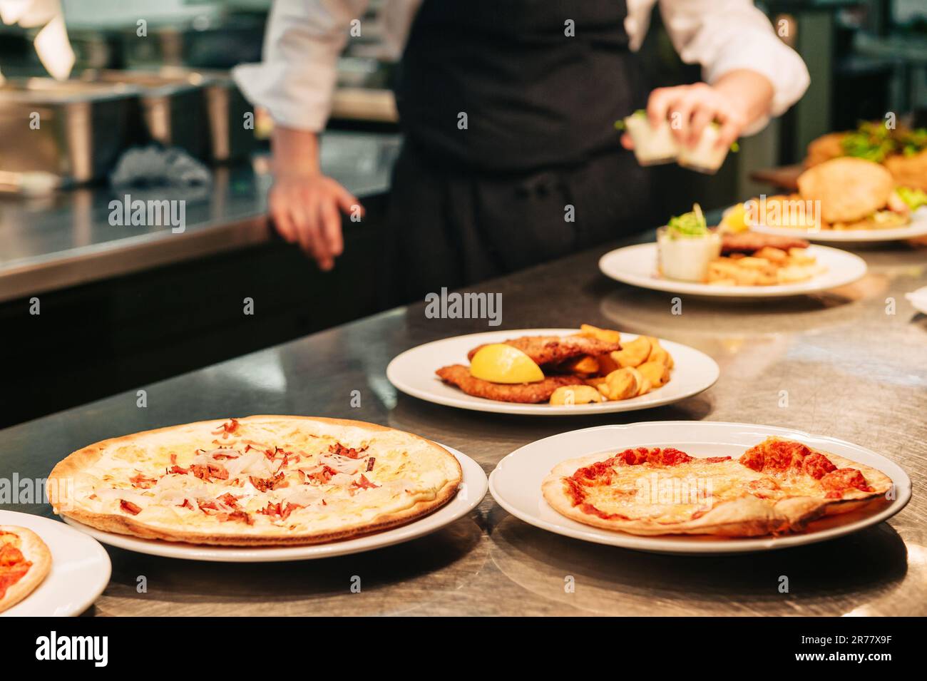Food orders on the kitchen table in the restaurant Stock Photo - Alamy