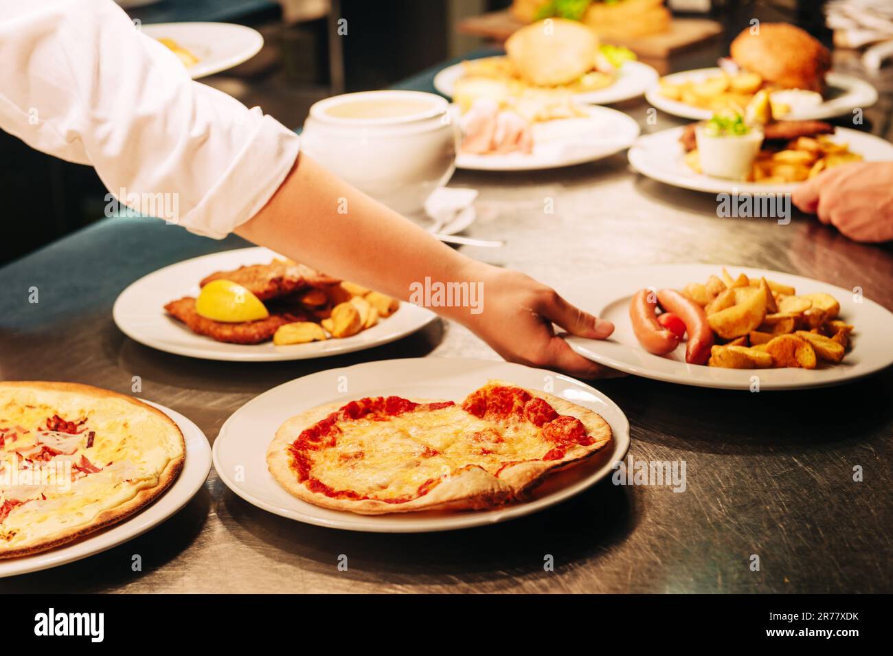Food orders on the kitchen table in the restaurant Stock Photo - Alamy