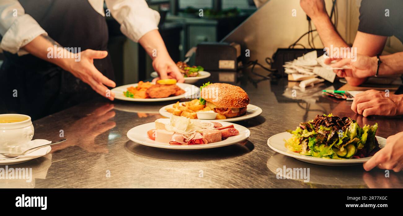 Food orders on the kitchen table in the restaurant Stock Photo - Alamy