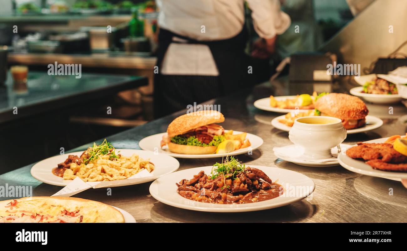 Food orders on the kitchen table in the restaurant Stock Photo - Alamy