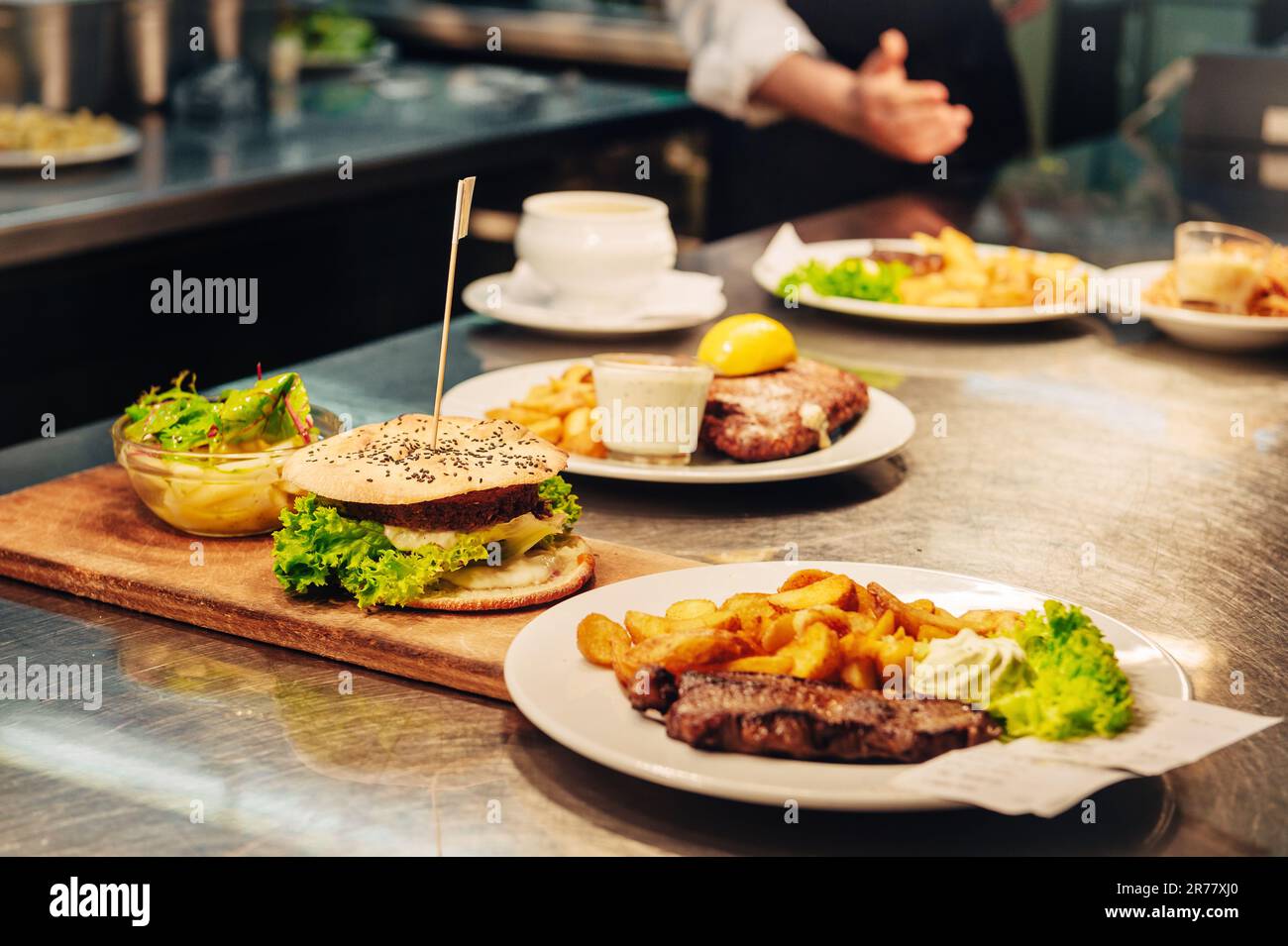 Food orders on the kitchen table in the restaurant, veggie hamburger ...