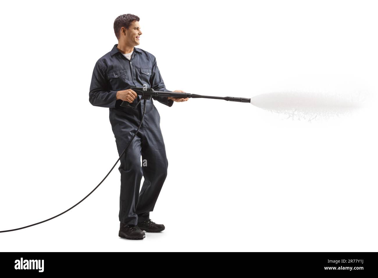 Man in a uniform using a pressure washer isolated on white background ...
