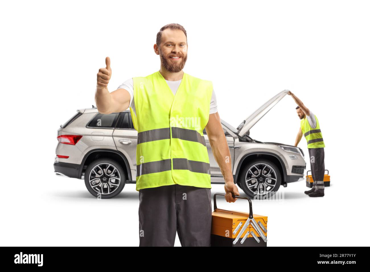 Roadside assistance compay workers checking a SUV and gesturing thumbs ...