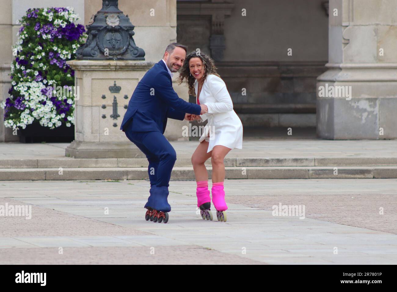 Spanish bride and groom rollerblade towards their wedding photographer ...