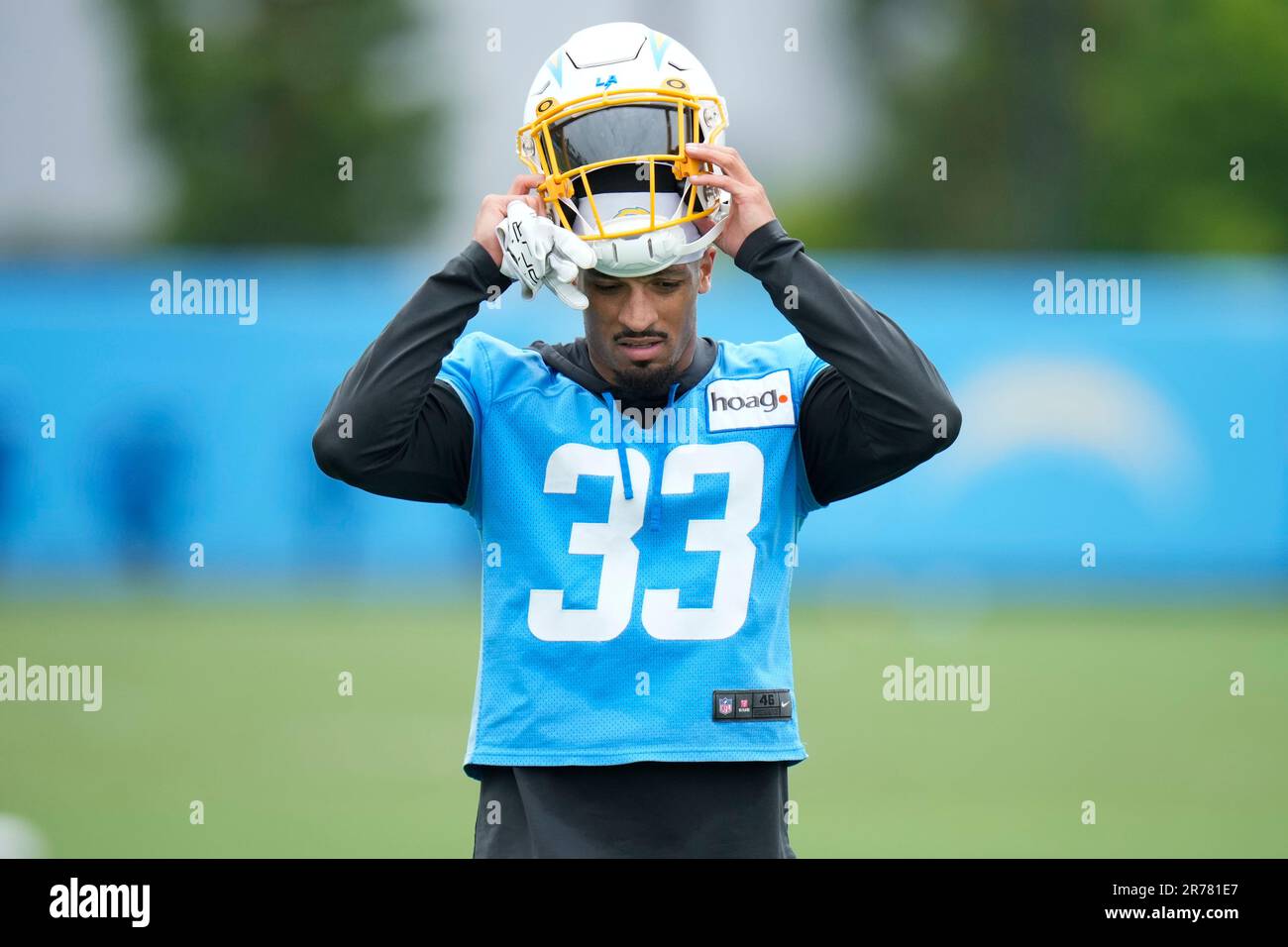 Los Angeles Chargers cornerback Deane Leonard (33) puts on his helmet ...