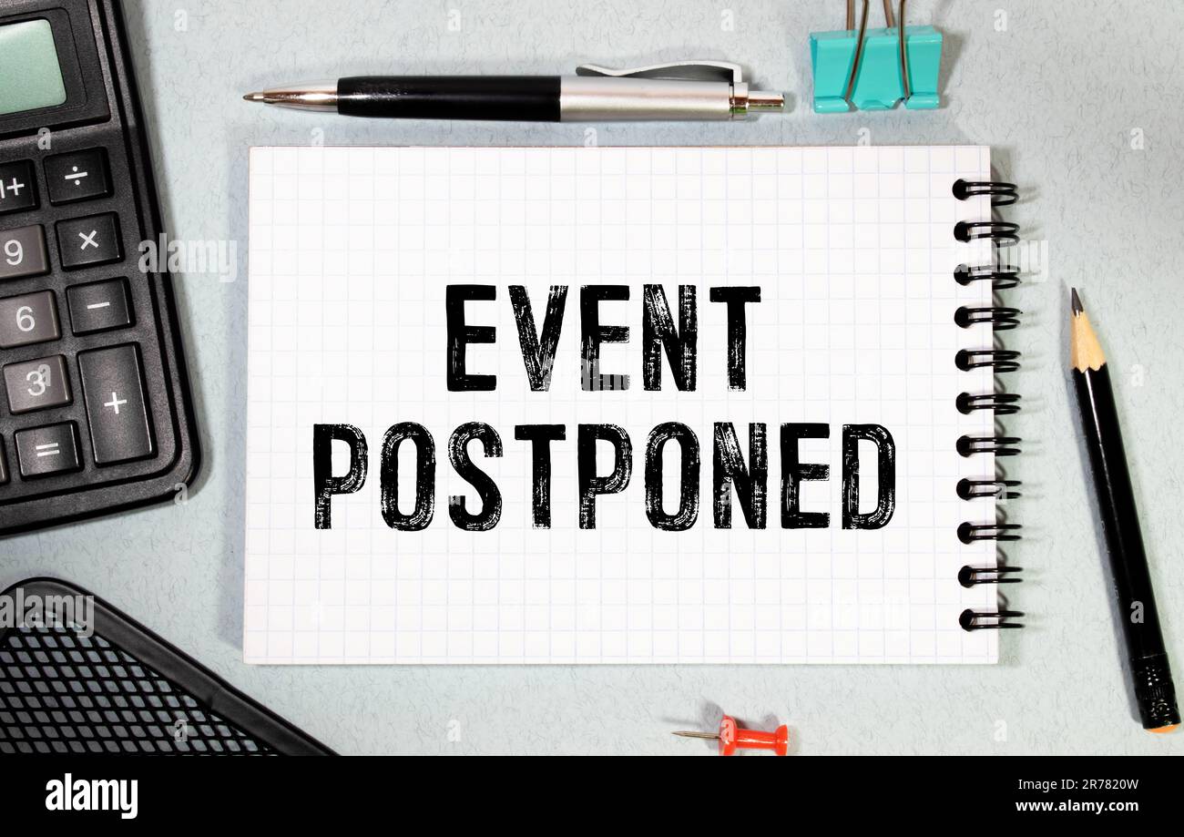 Daily planner with the entry Event postponed Stock Photo - Alamy