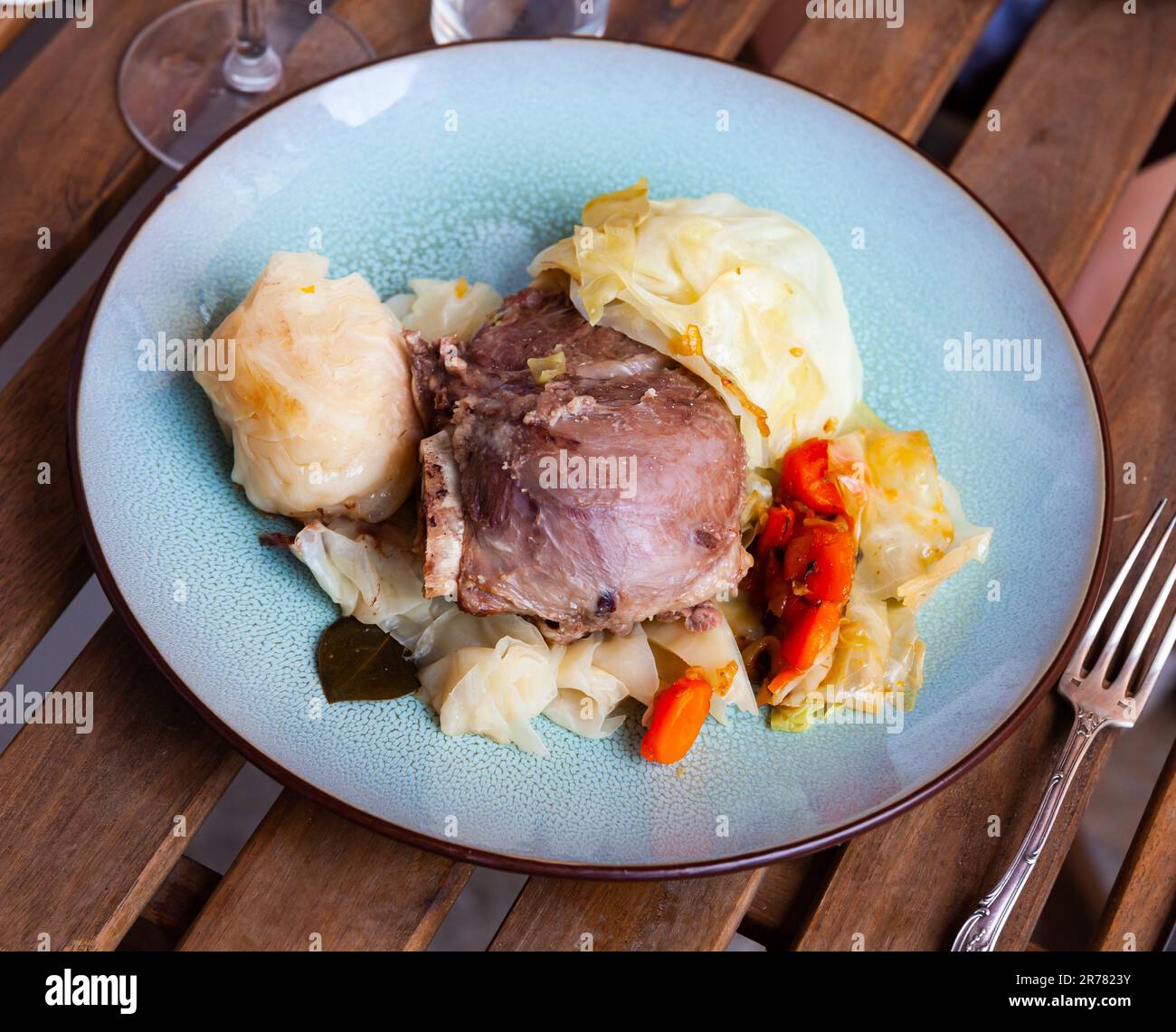 Spanish traditional dish - pork cheeks with cabbage Stock Photo - Alamy