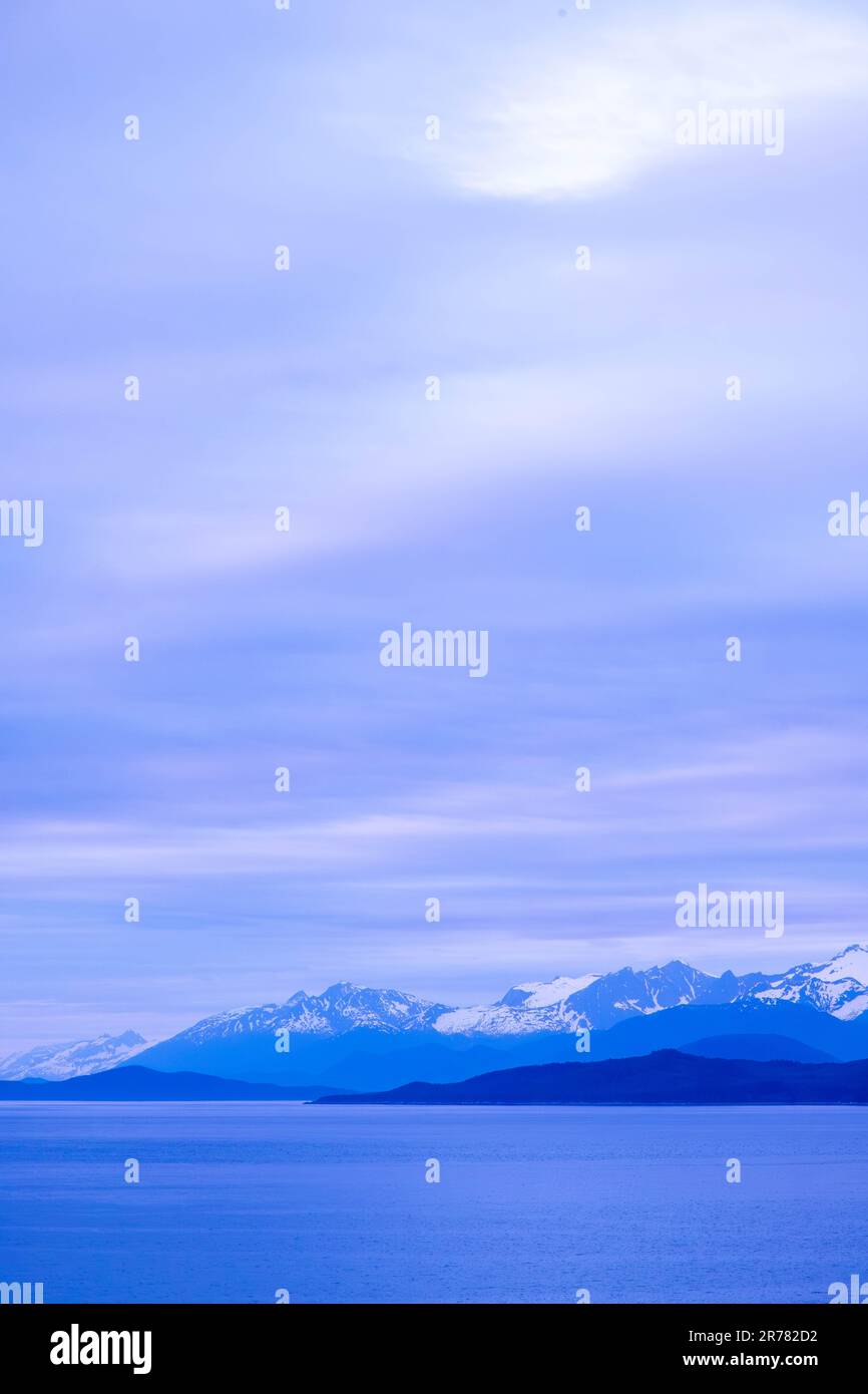 Snow capped mountains and coastal Alaska under pastel sunset Stock ...