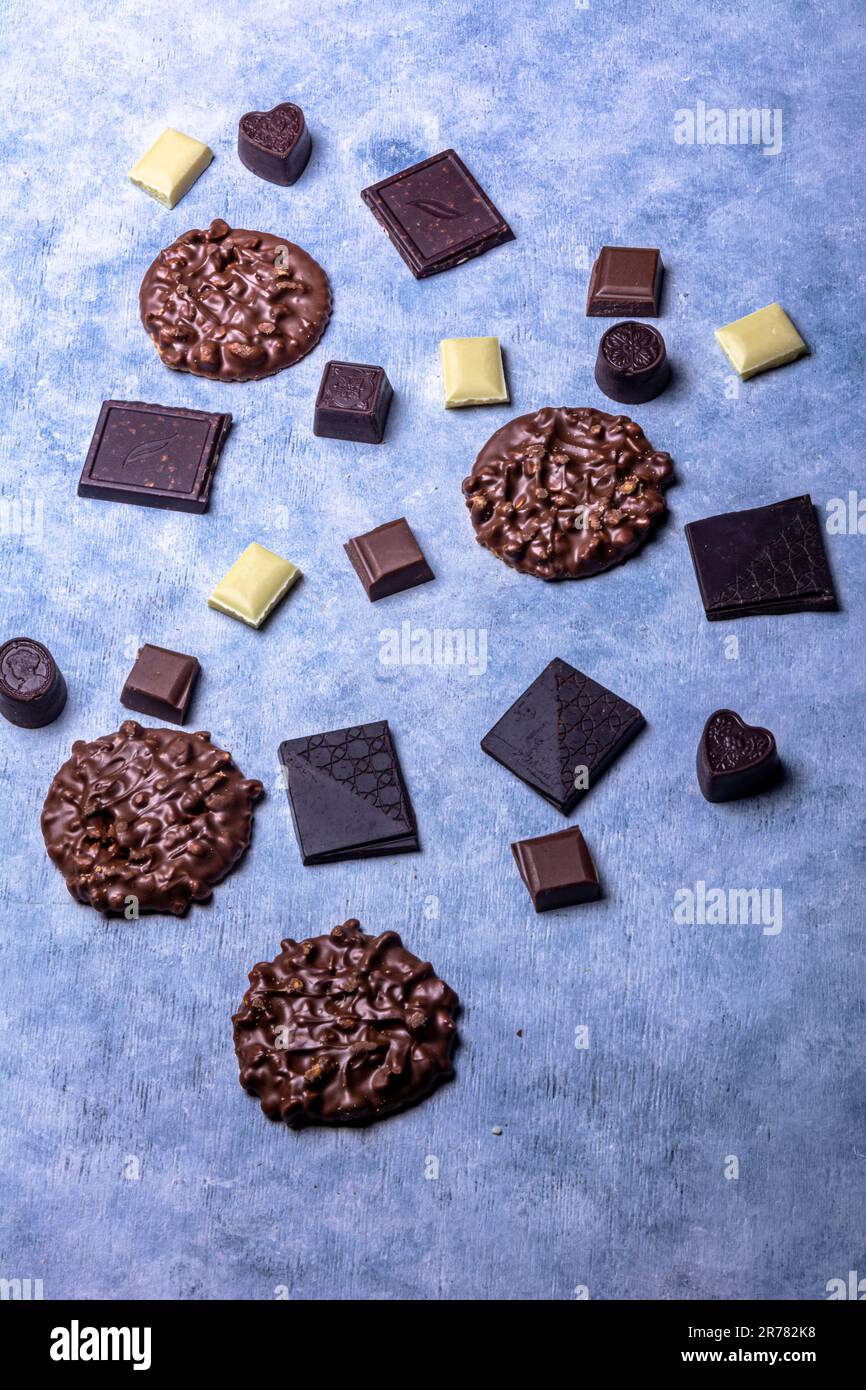 Variety of chocolate products photographed in studio on a light grey ...
