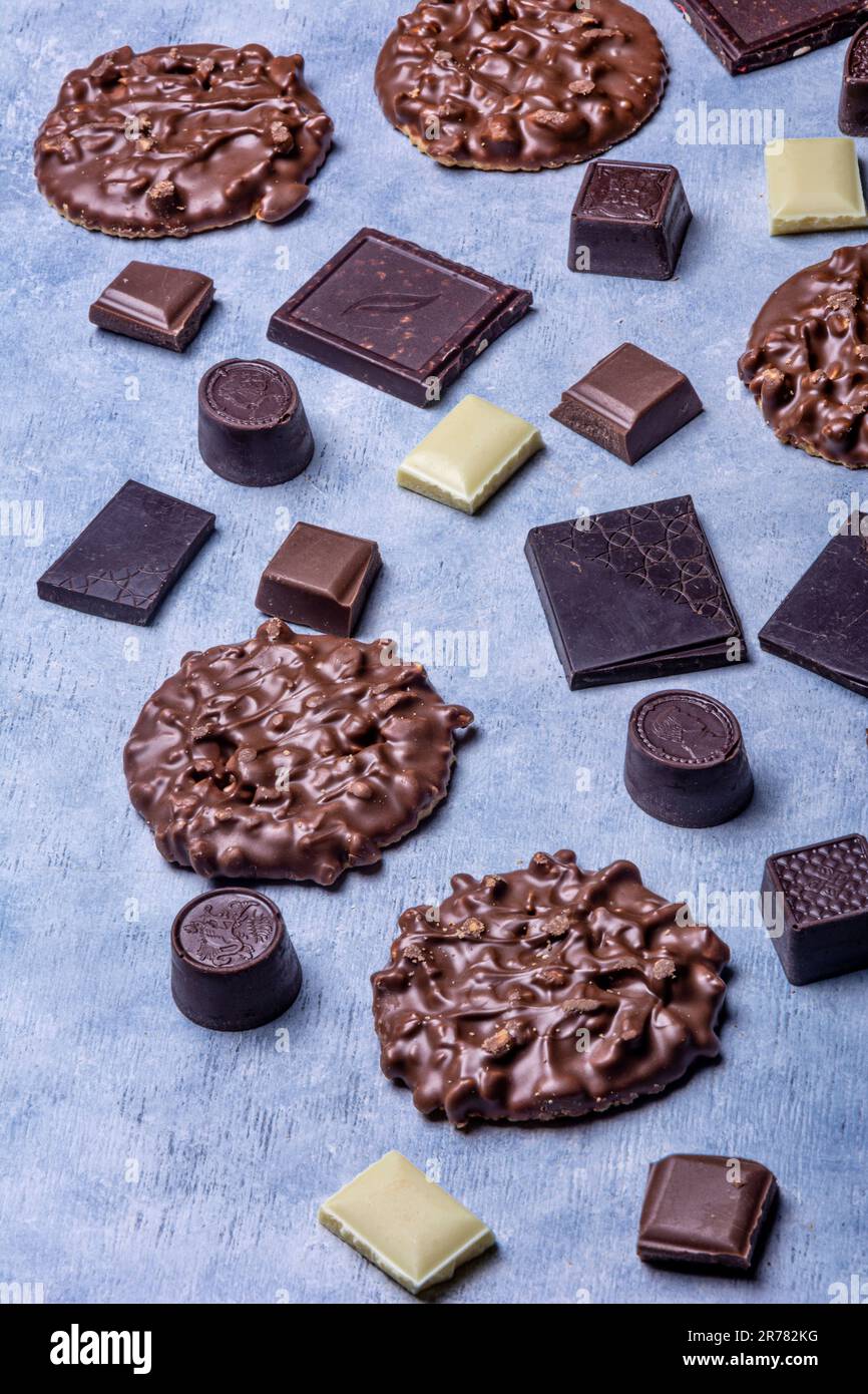 Variety of chocolate products photographed in studio on a light grey ...
