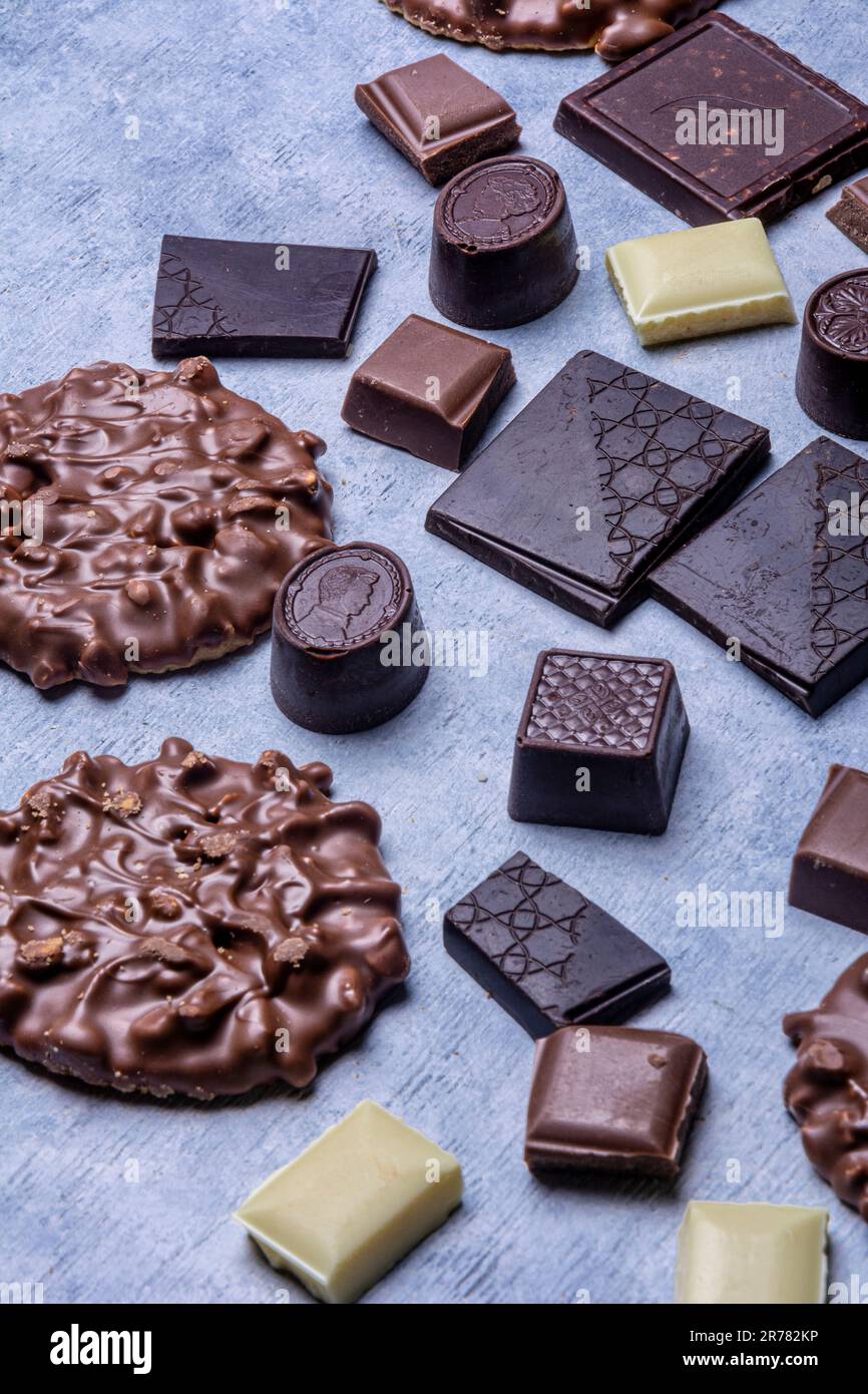 Variety of chocolate products photographed in studio on a light grey ...
