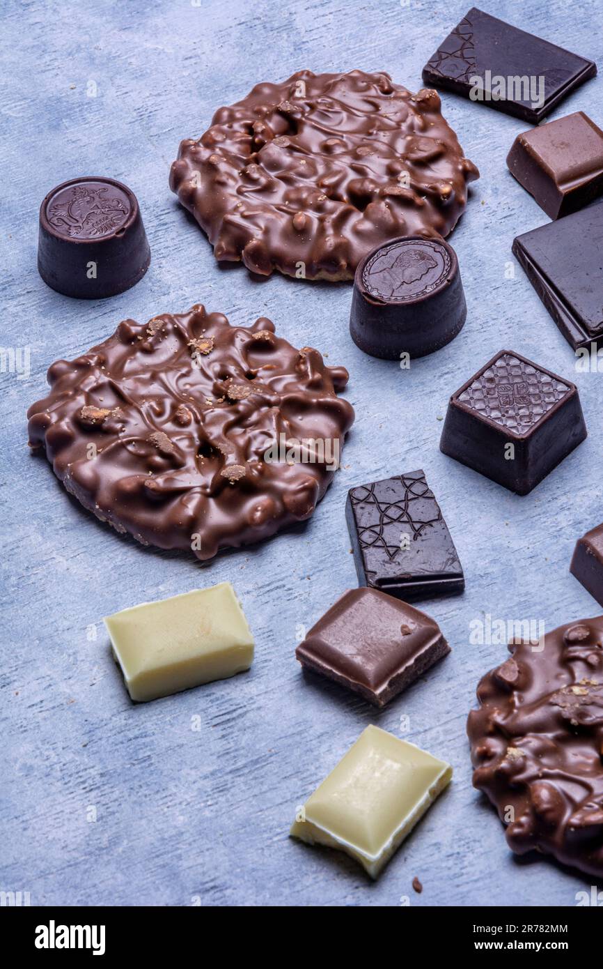 Variety of chocolate products photographed in studio on a light grey ...