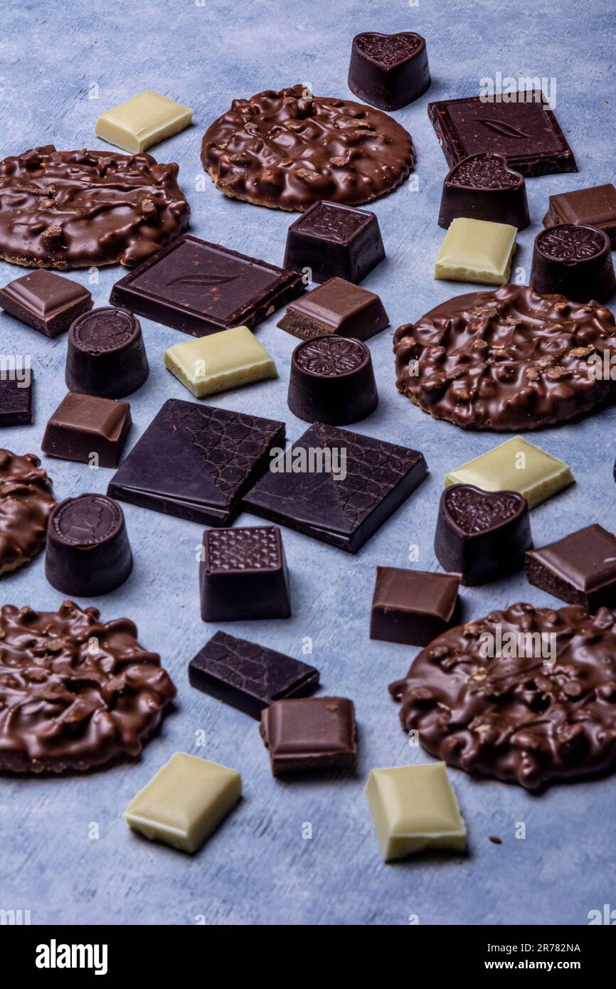 Variety of chocolate products photographed in studio on a light grey ...
