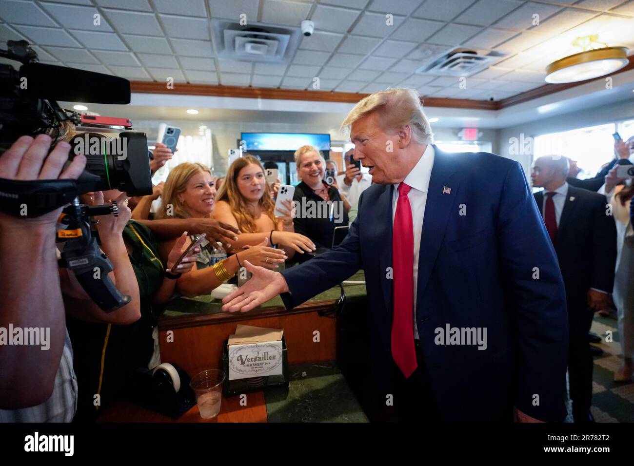 Former President Donald Trump greets supporters as he visits Versailles ...
