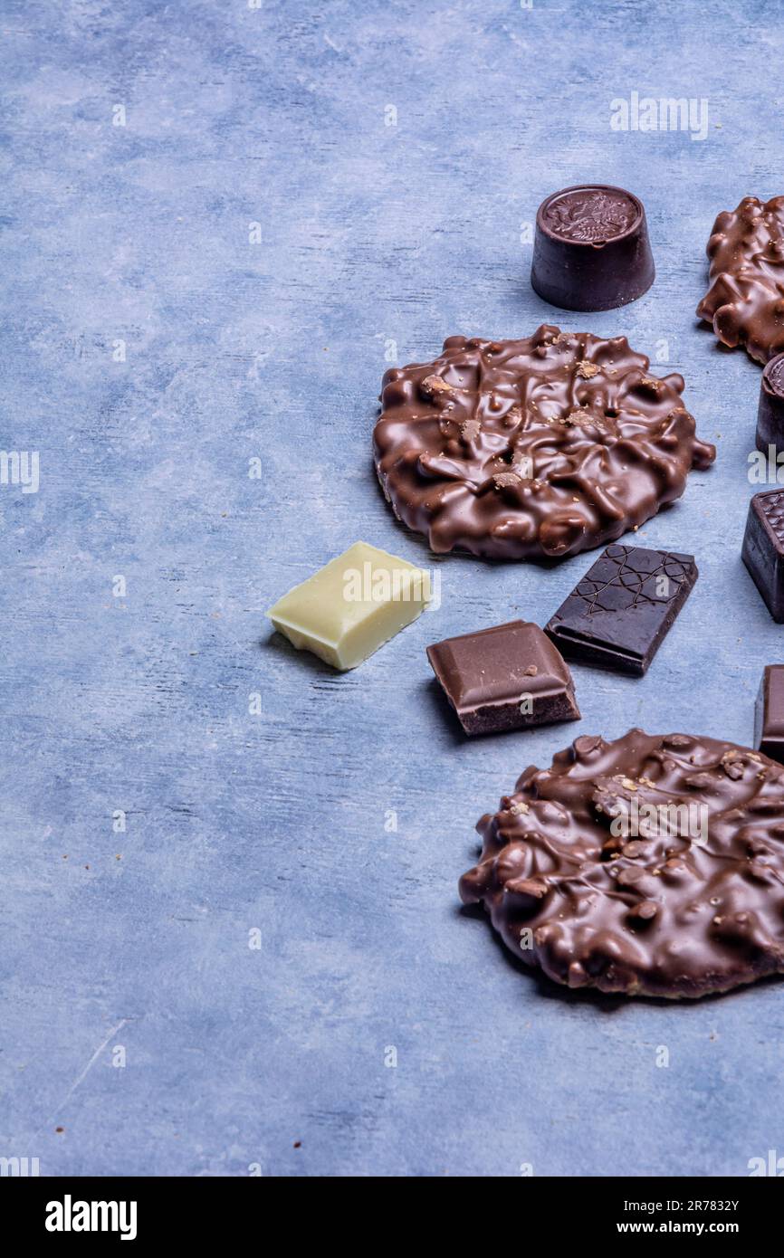 Variety of chocolate products photographed in studio on a light grey ...
