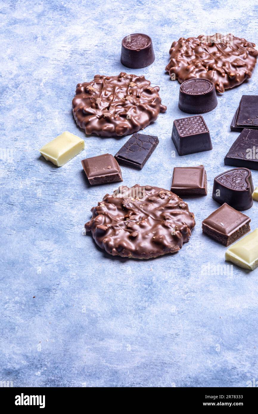 Variety of chocolate products photographed in studio on a light grey ...