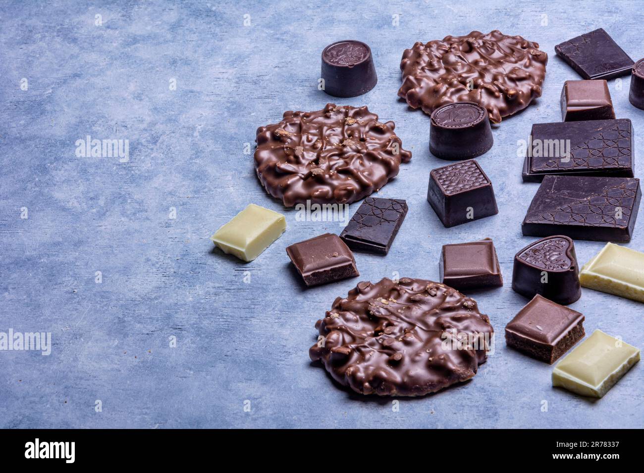 Variety of chocolate products photographed in studio on a light grey ...