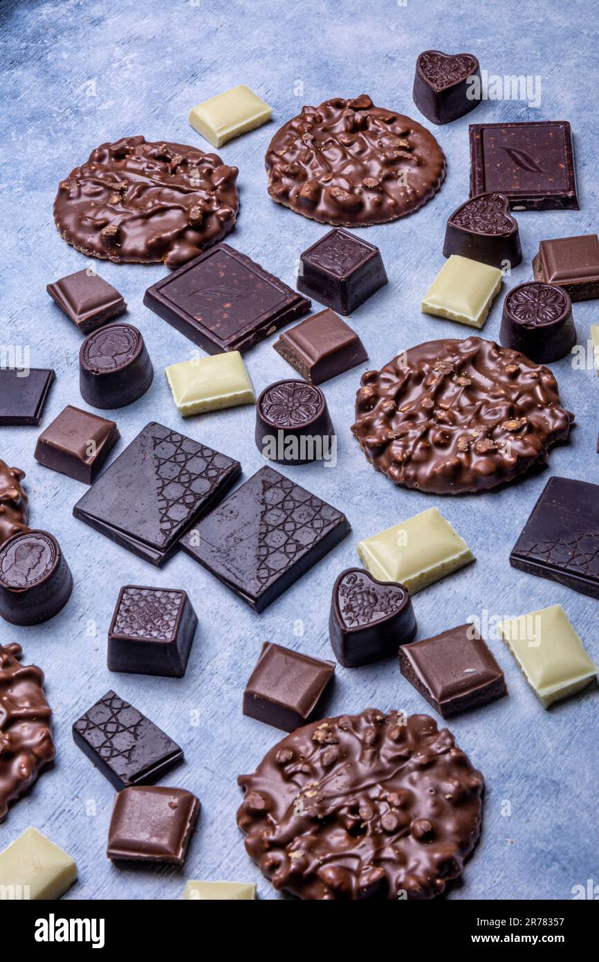 Variety of chocolate products photographed in studio on a light grey ...