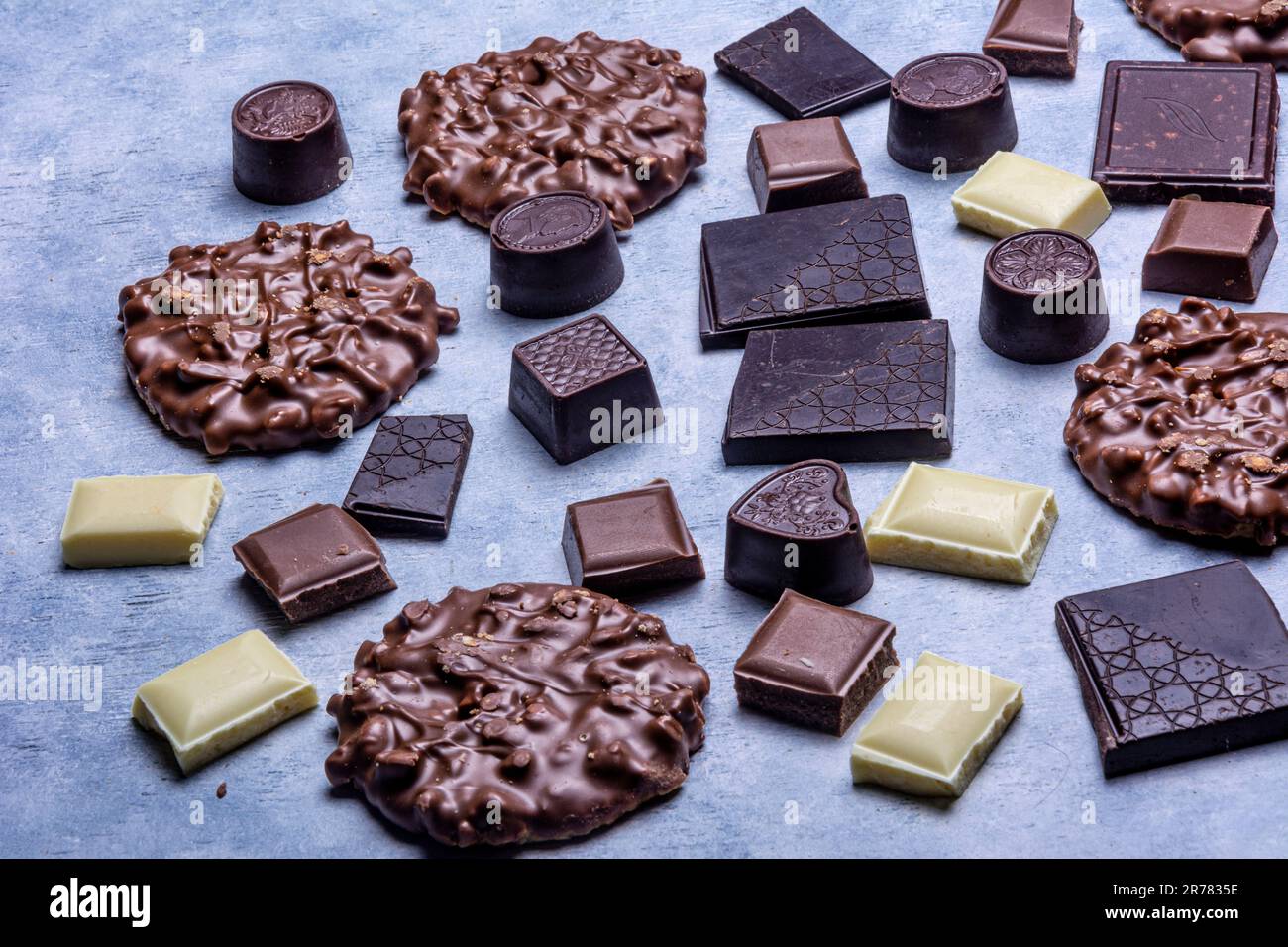 Variety of chocolate products photographed in studio on a light grey ...