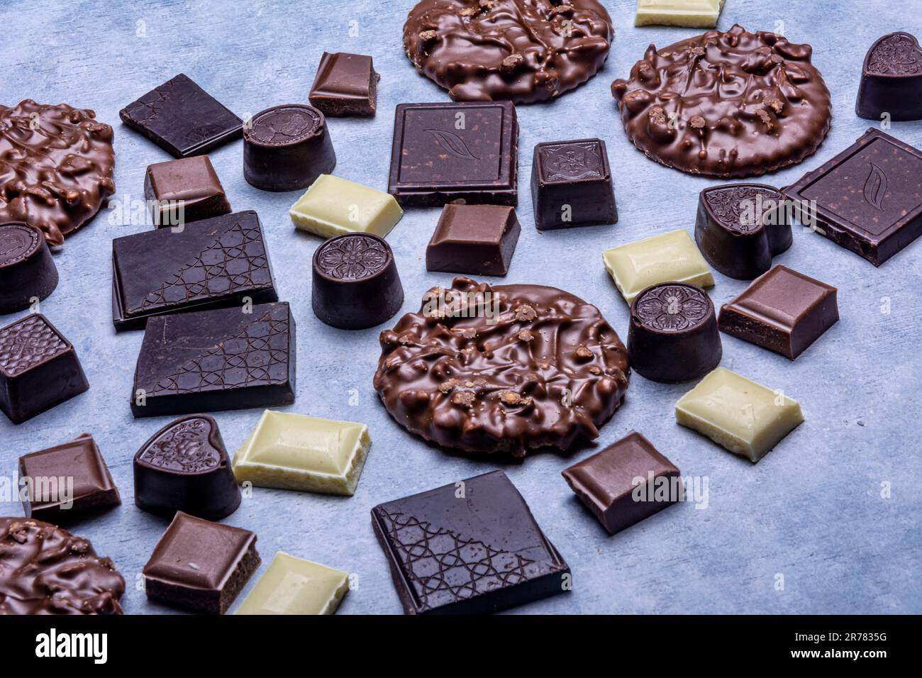 Variety of chocolate products photographed in studio on a light grey ...