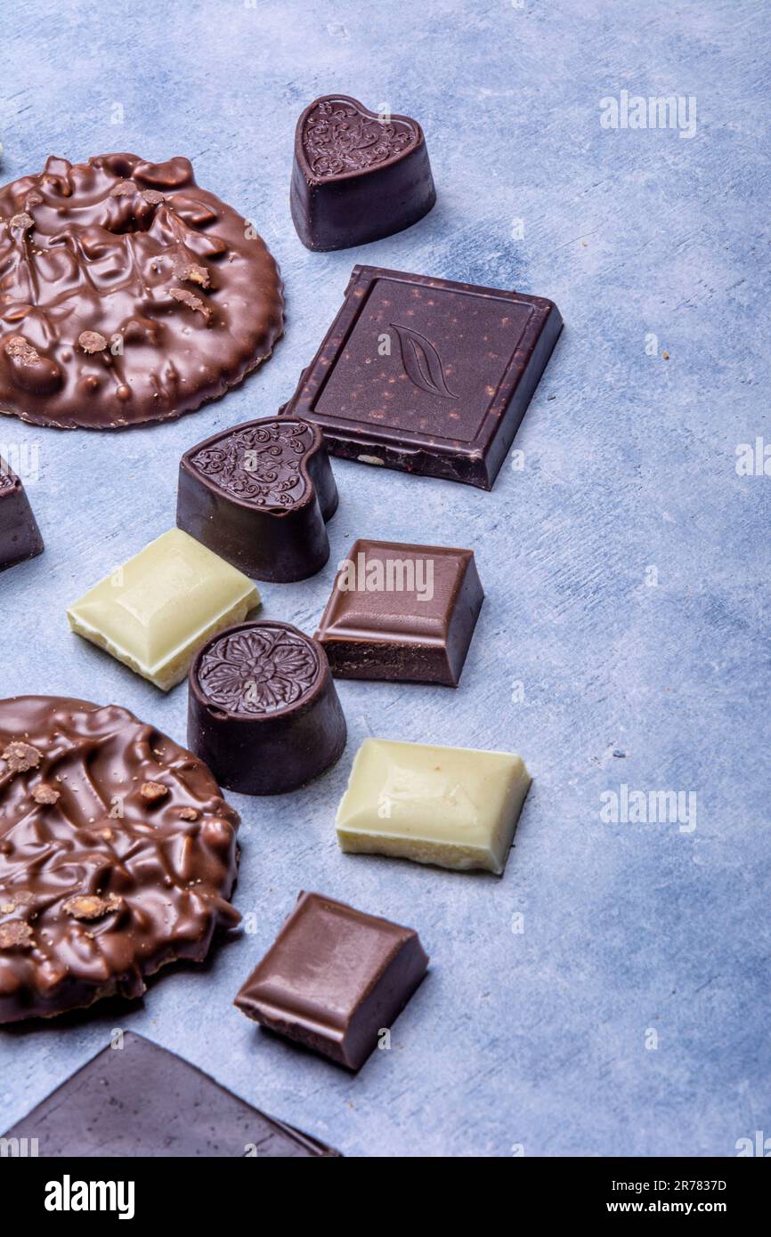 Variety of chocolate products photographed in studio on a light grey ...