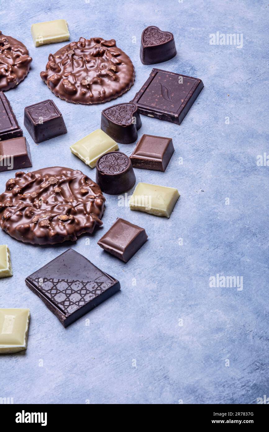 Variety of chocolate products photographed in studio on a light grey ...