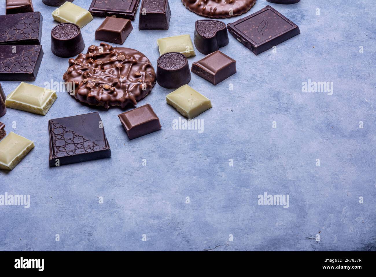 Variety of chocolate products photographed in studio on a light grey ...