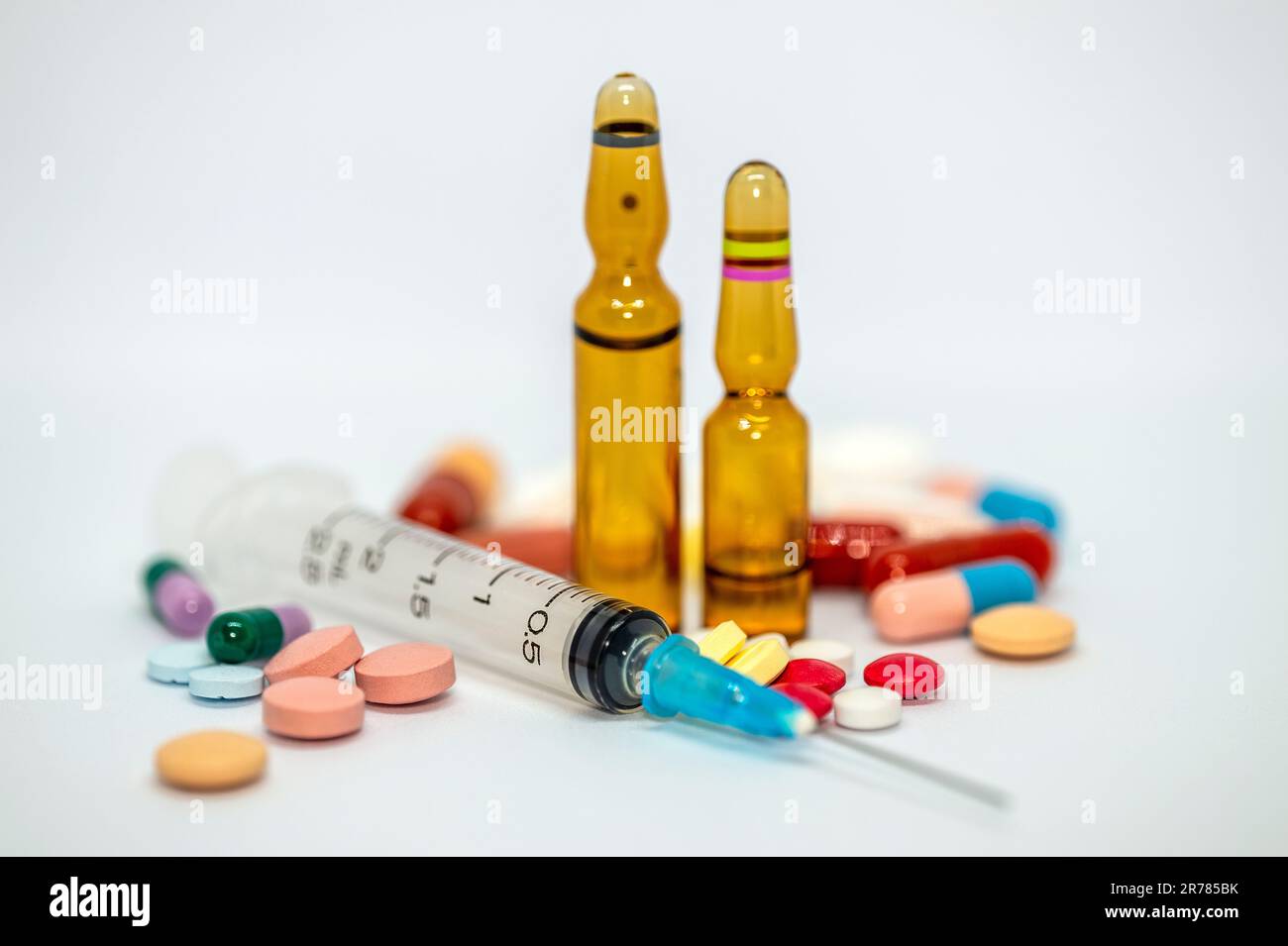Collection of medicines, pills, capsules, ampoules and a syringe with ...