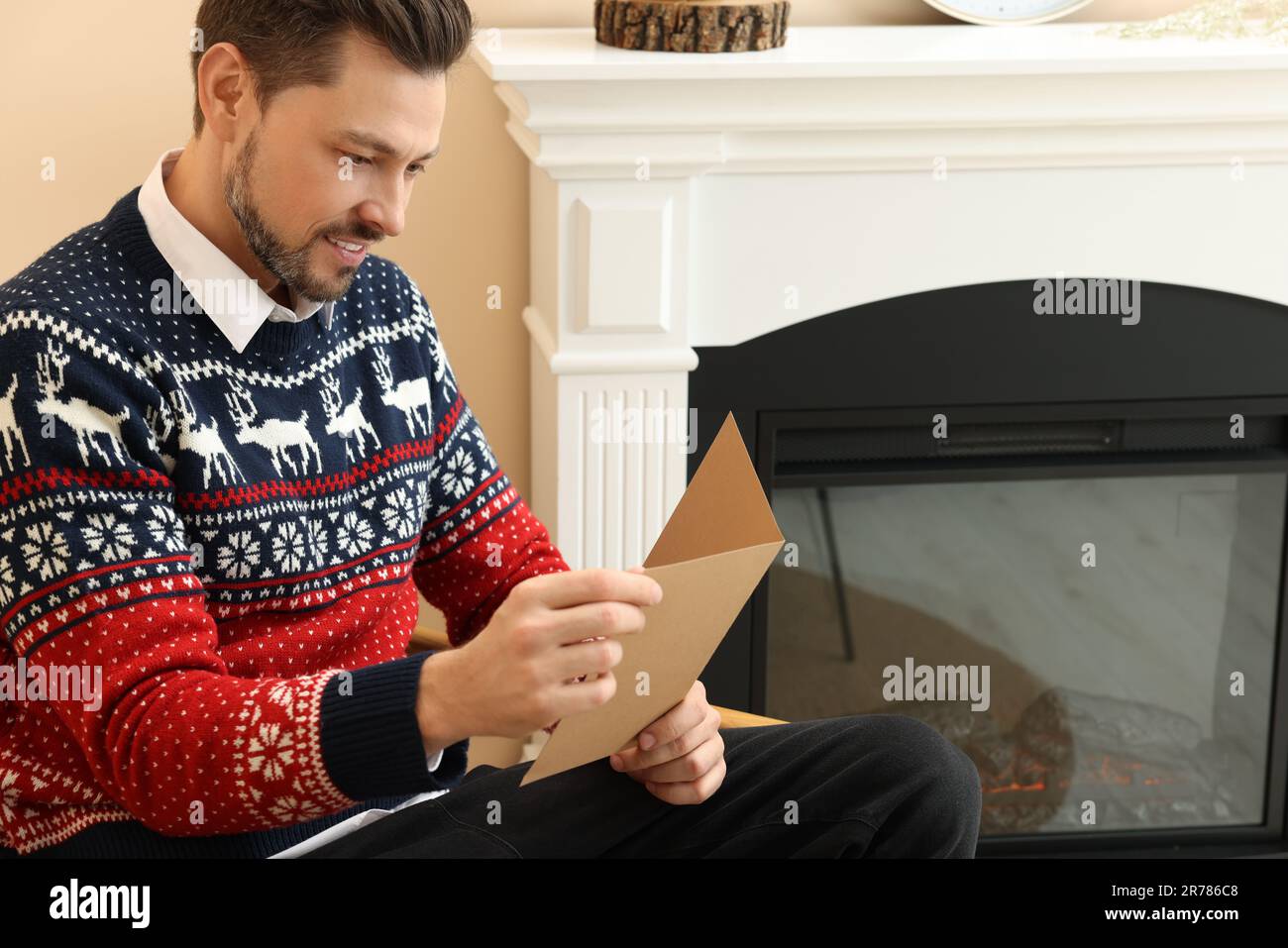 Happy man reading greeting card in living room Stock Photo - Alamy