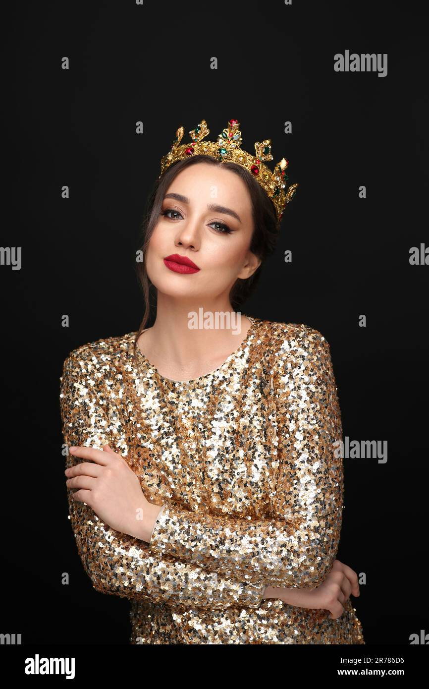 Beautiful young woman wearing luxurious crown on black background Stock Photo - Alamy