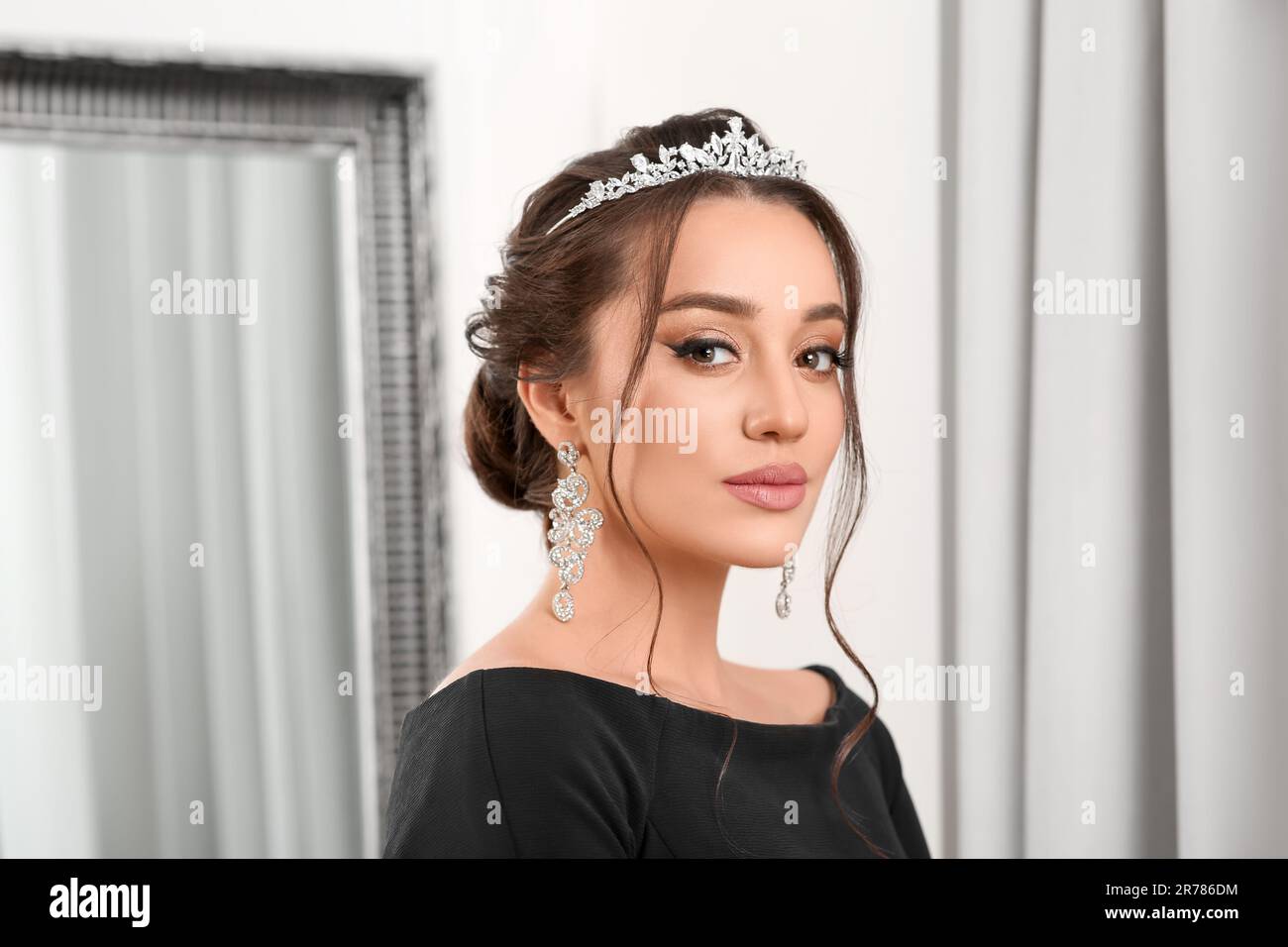 Beautiful young woman wearing luxurious tiara indoors Stock Photo - Alamy