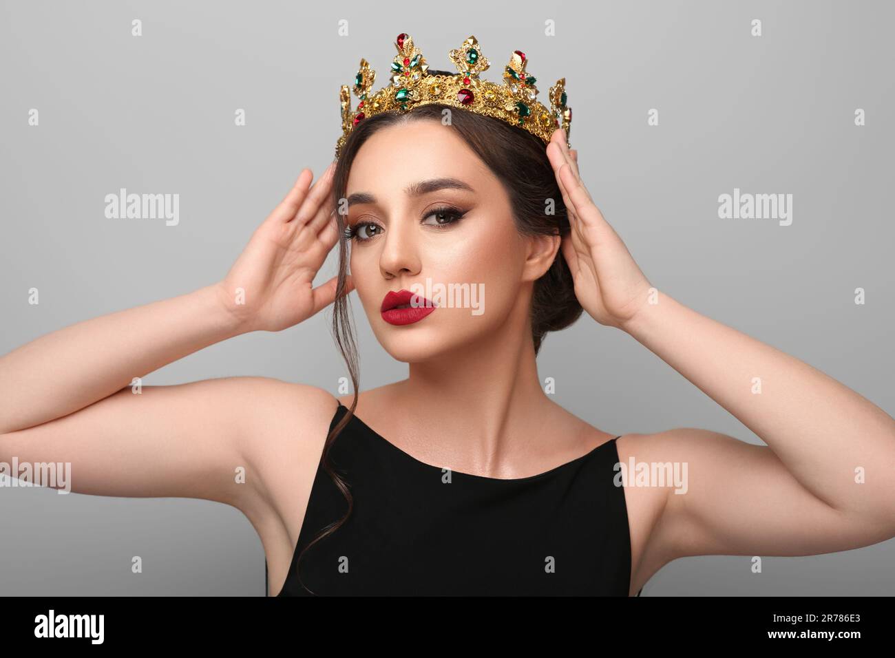 Beautiful young woman wearing luxurious crown on light grey background Stock Photo - Alamy