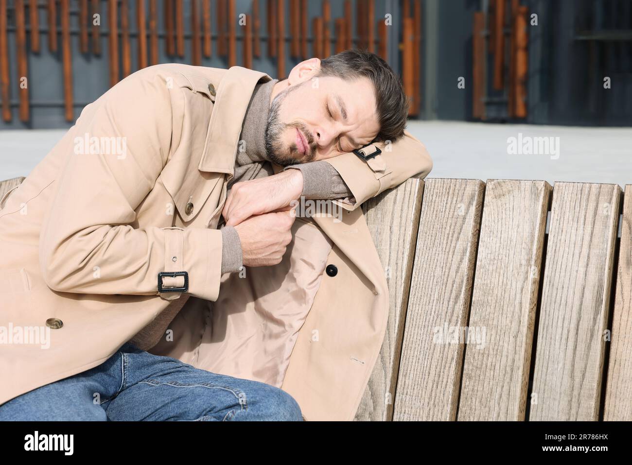 Tired man sleeping on bench outdoors. Space for text Stock Photo - Alamy