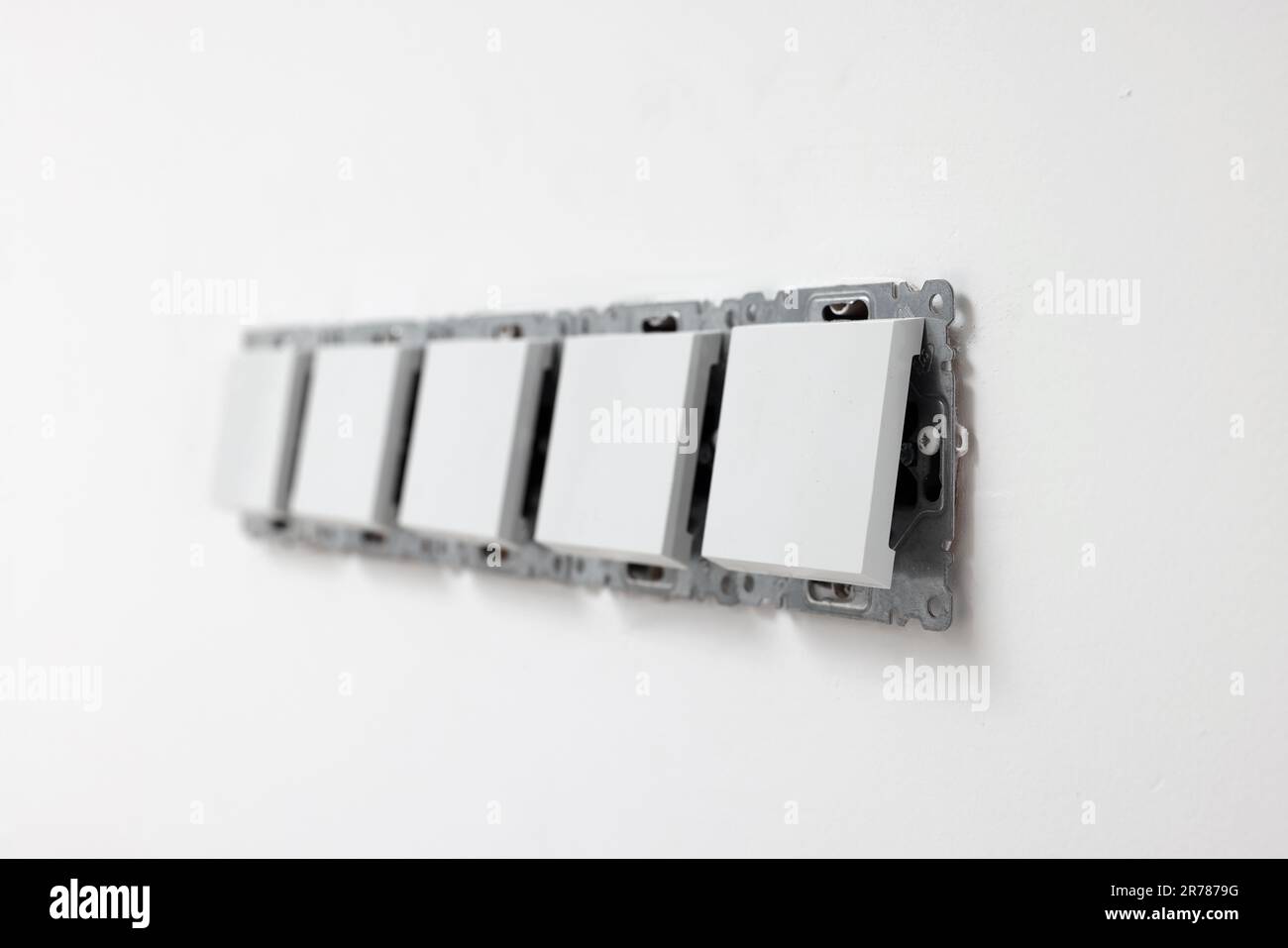 Modern plastic switches on white wall. Installing lighting Stock Photo ...