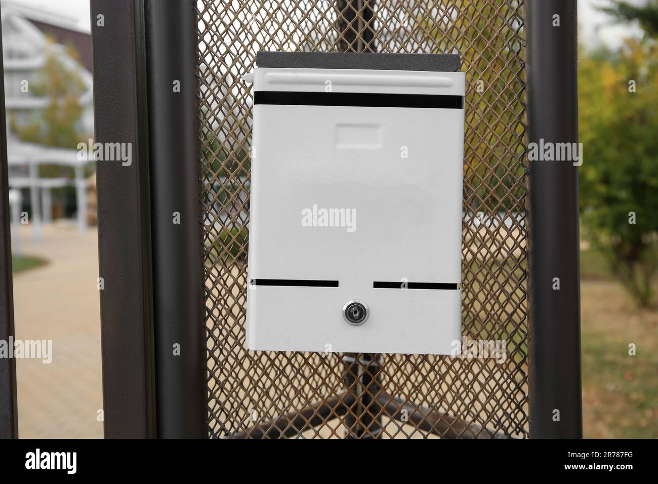 White metal letter box on fence outdoors Stock Photo - Alamy