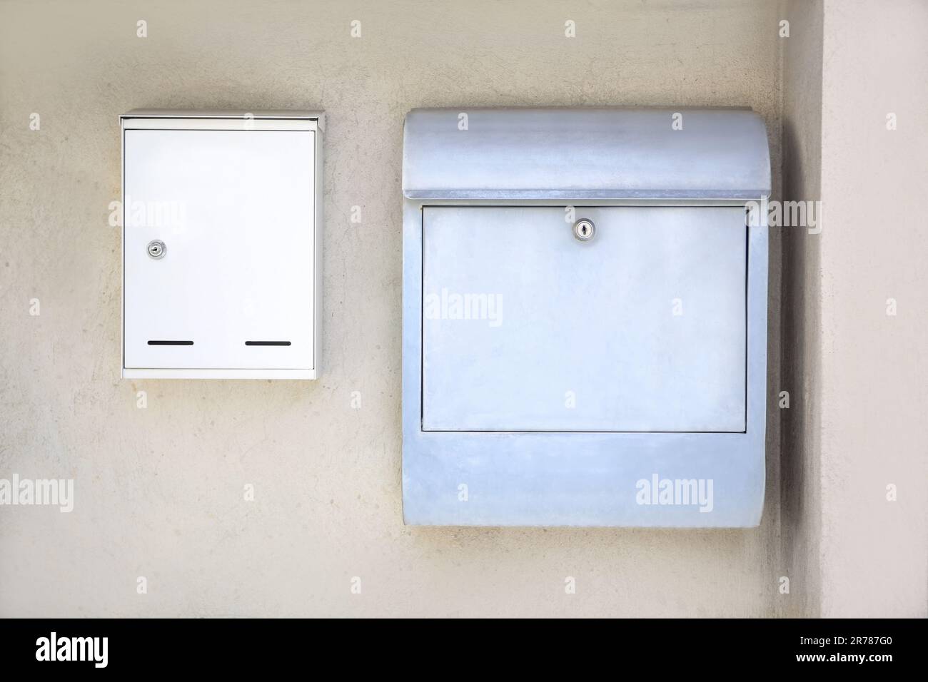 White metal letter boxes on beige wall Stock Photo - Alamy