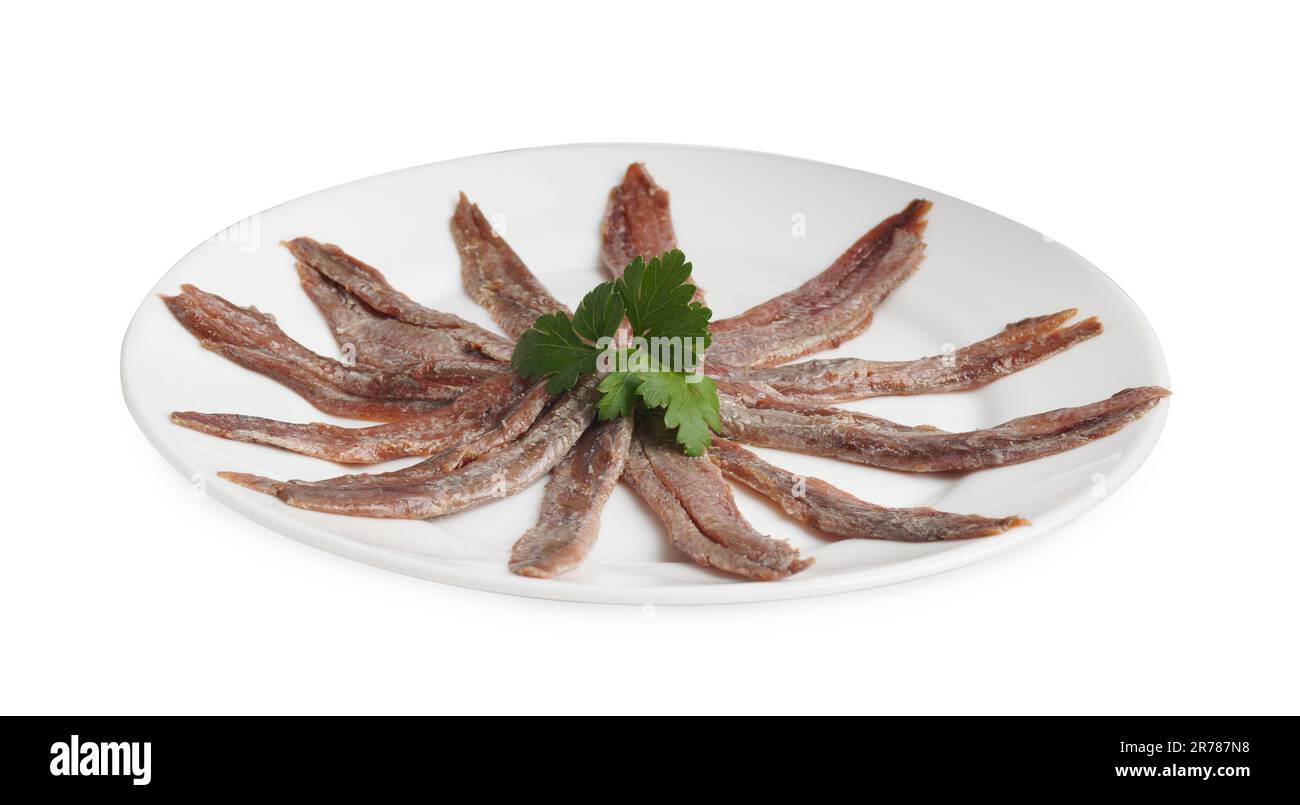 Plate with anchovy fillets and parsley on white background Stock Photo ...