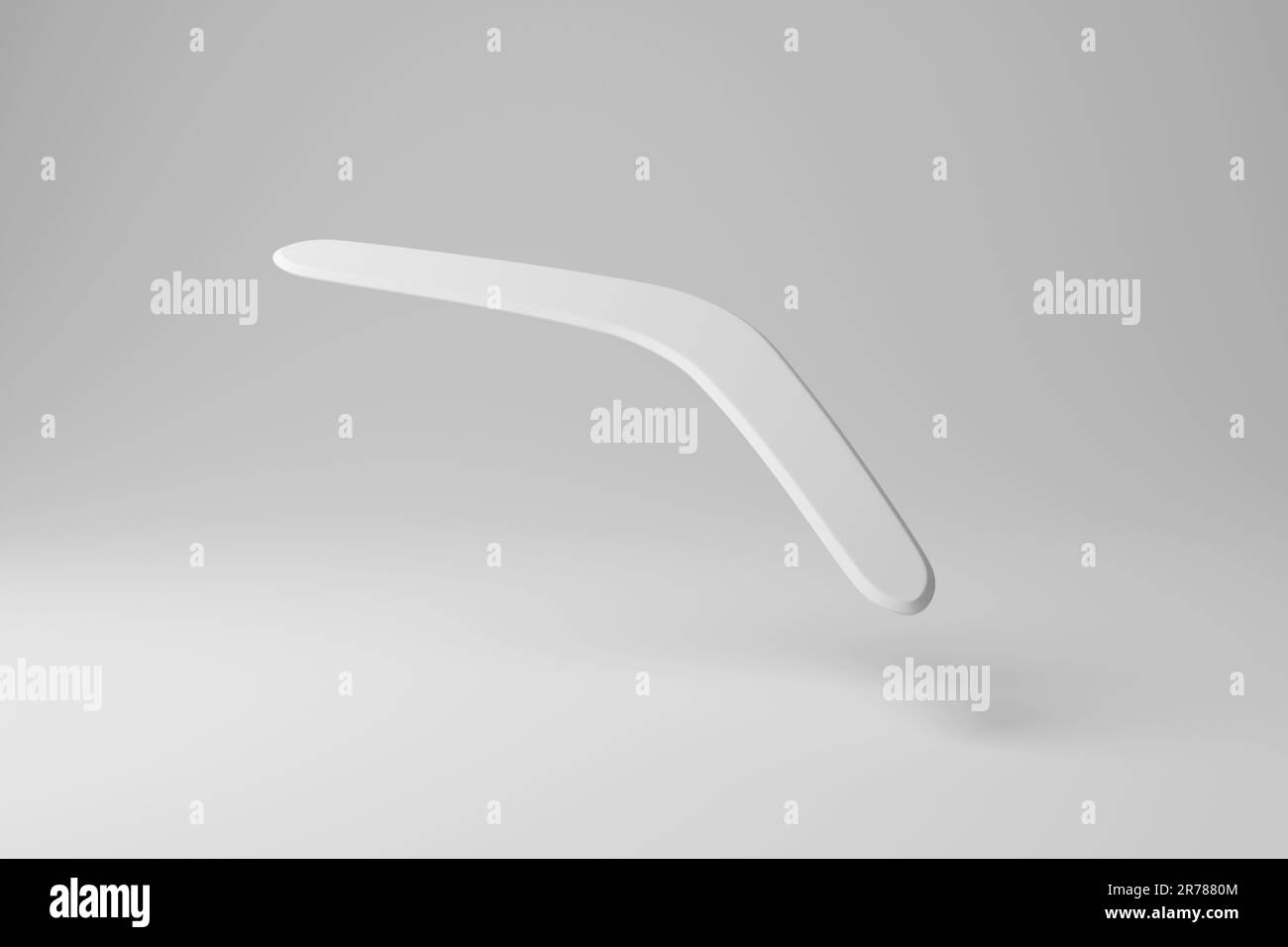 White boomerang flying in mid-air on white background creating ...
