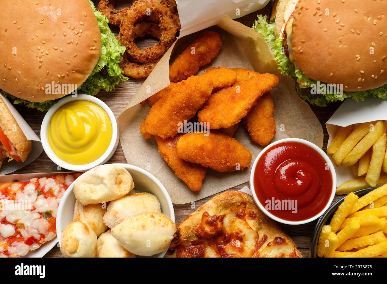French fries, burgers and other fast food as background, top view Stock ...