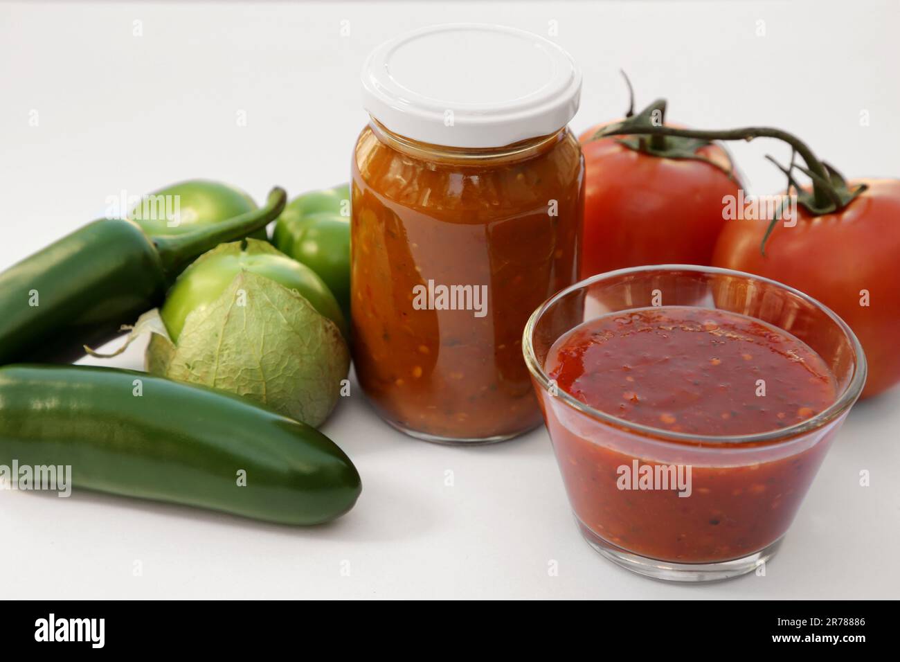 Delicious salsa sauce and ingredients on white background, closeup ...