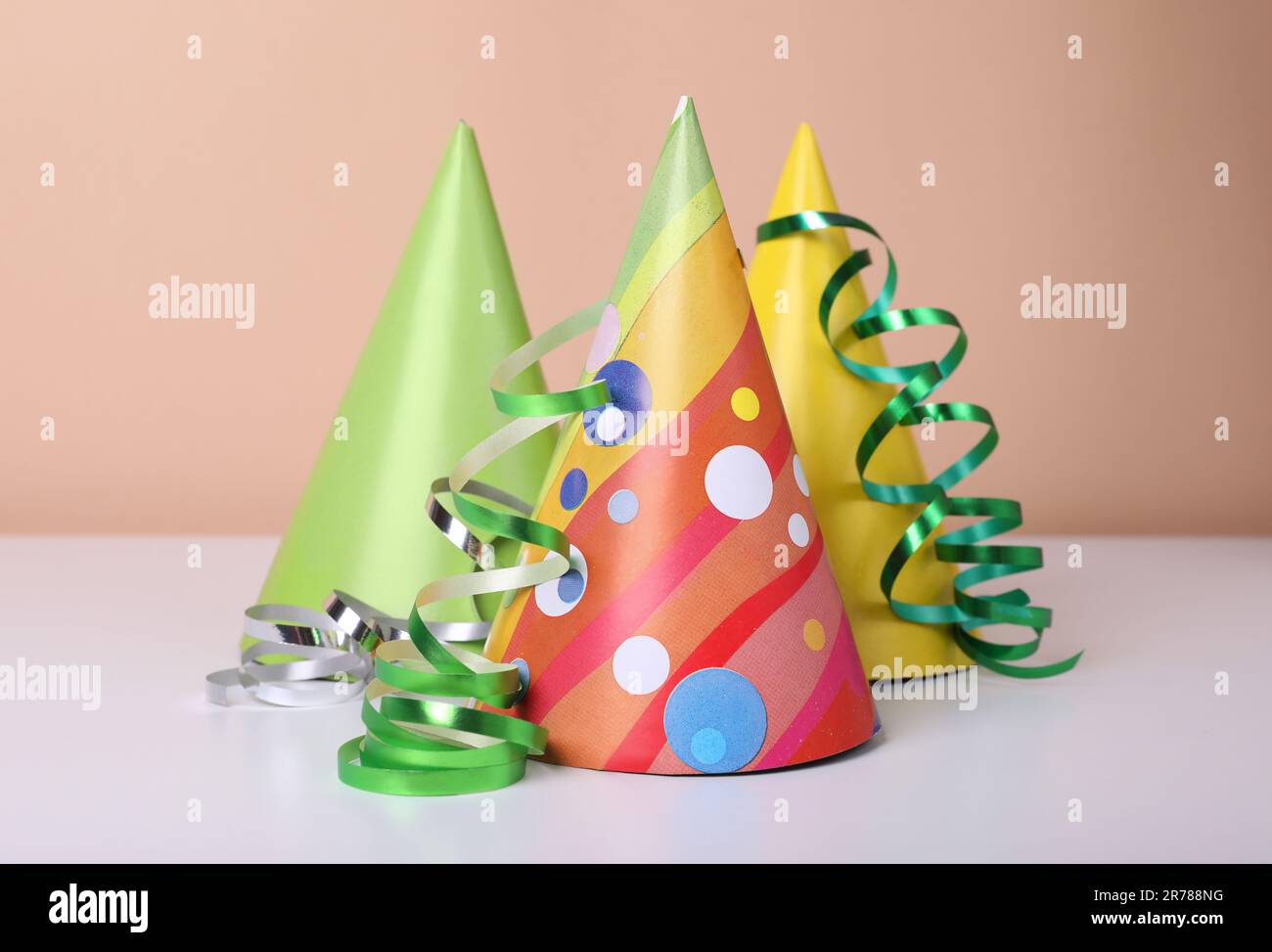 Colorful party hats and streamers on white table. Birthday celebration ...