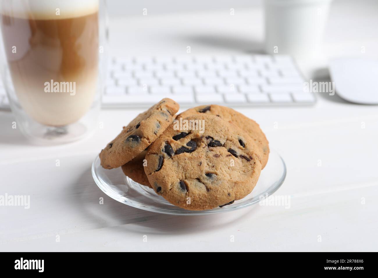Chocolate chip cookies on white wooden table at workplace Stock Photo ...