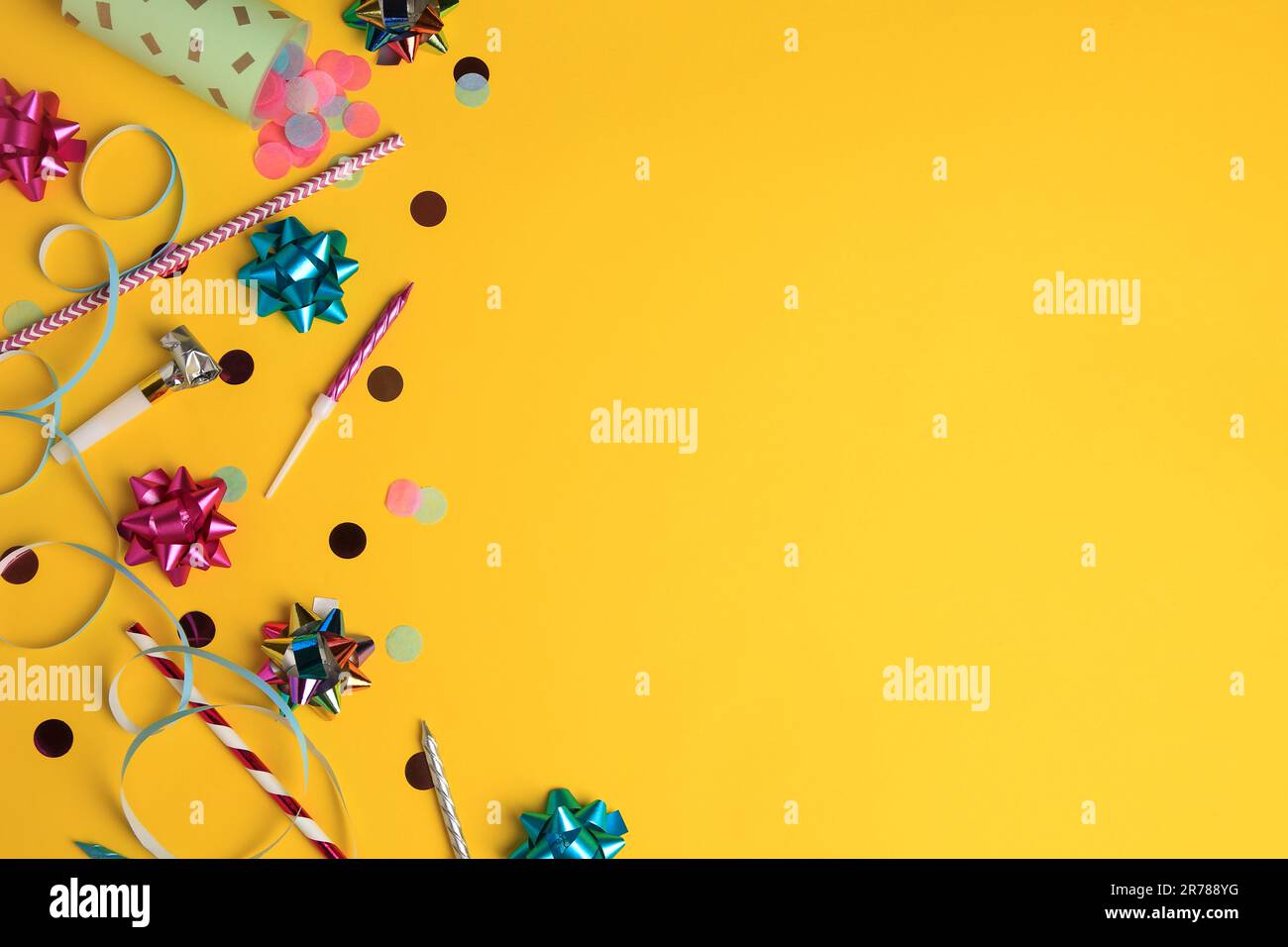 Party popper with confetti, blower and festive decor on orange ...