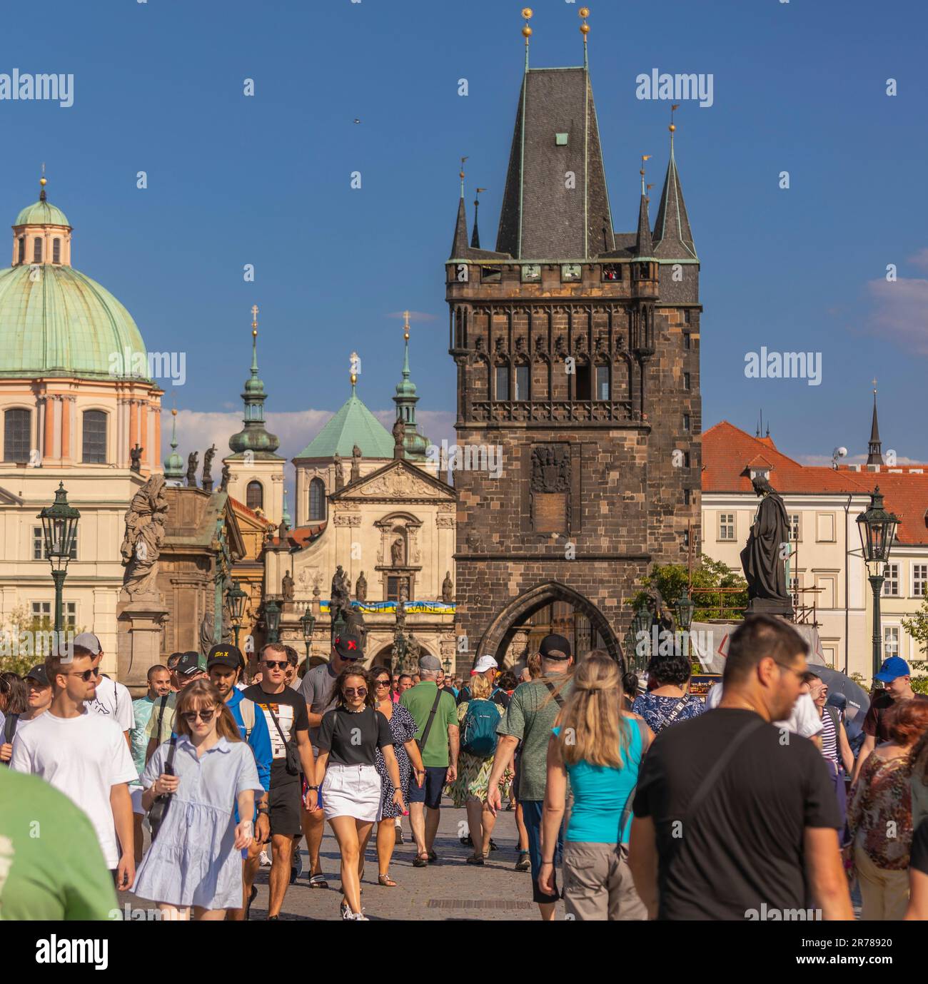 PRAGUE, CZECH REPUBLIC - Tourists crossing Charles Bridge. Old Town Bridge Tower at rear Stock ...