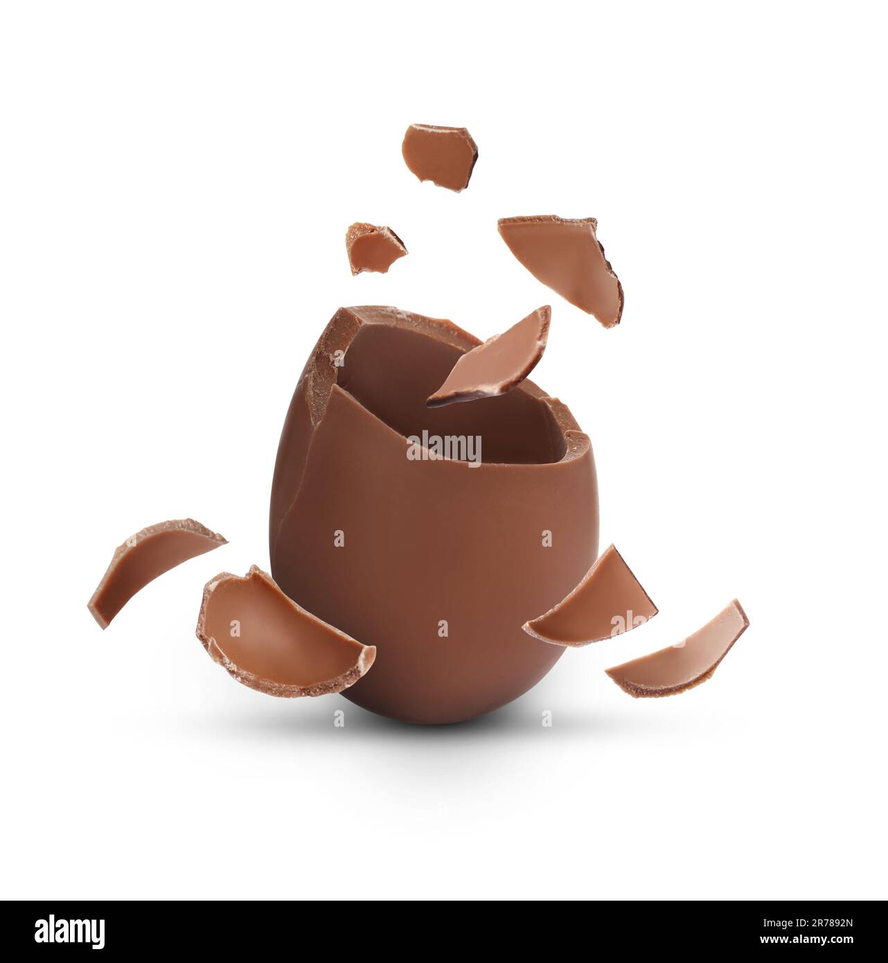 Exploded milk chocolate egg on white background Stock Photo - Alamy